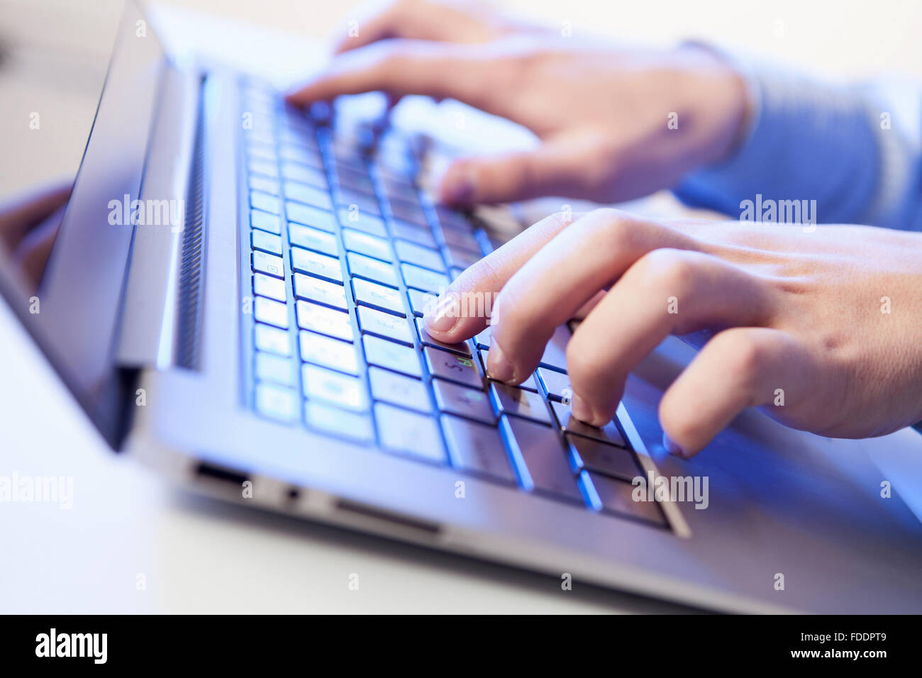 Click! Hands of a man on a keyboard with blue backlighting Stock Photo ...
