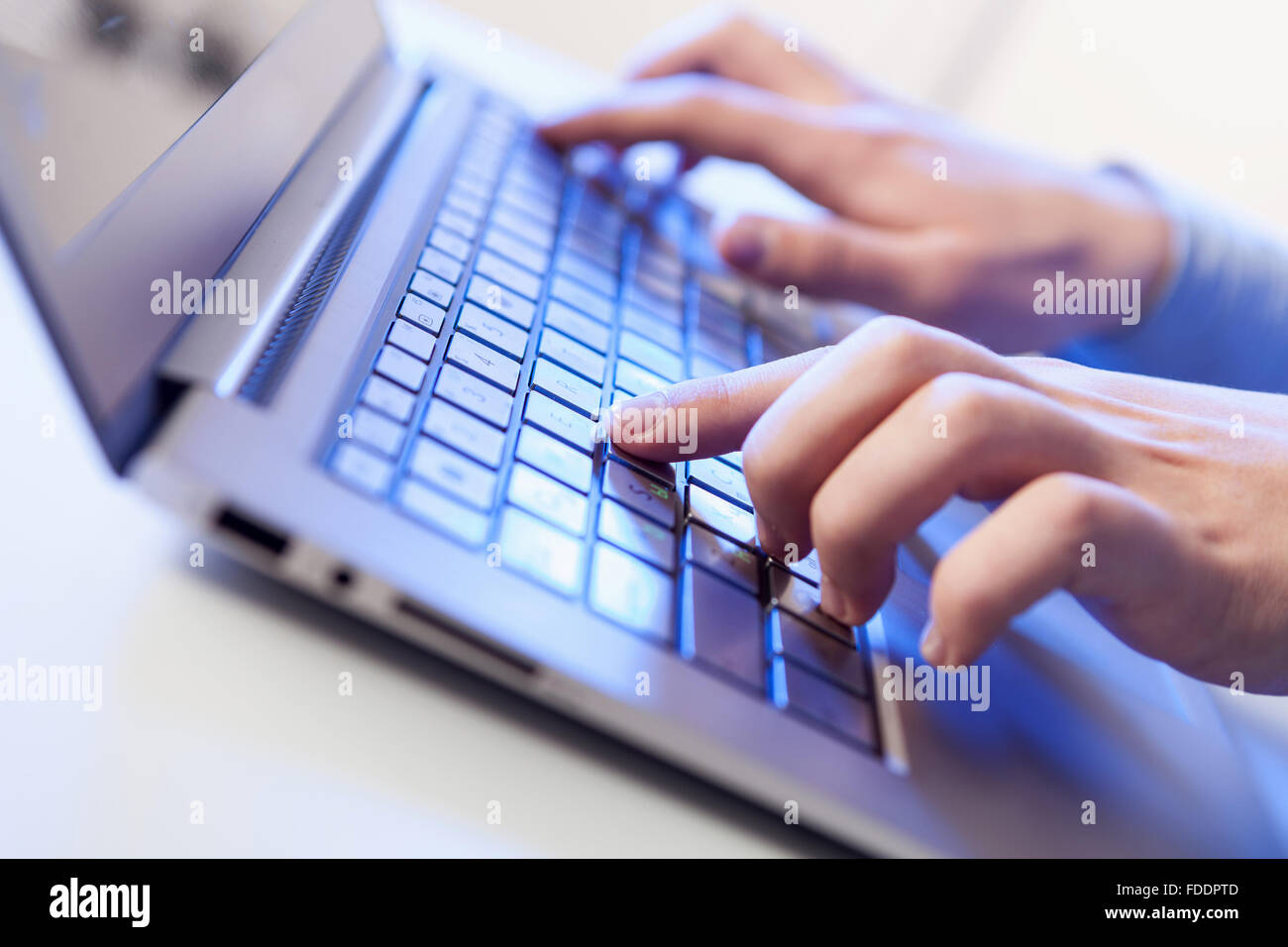Click! Hands of a man on a keyboard with blue backlighting Stock Photo ...