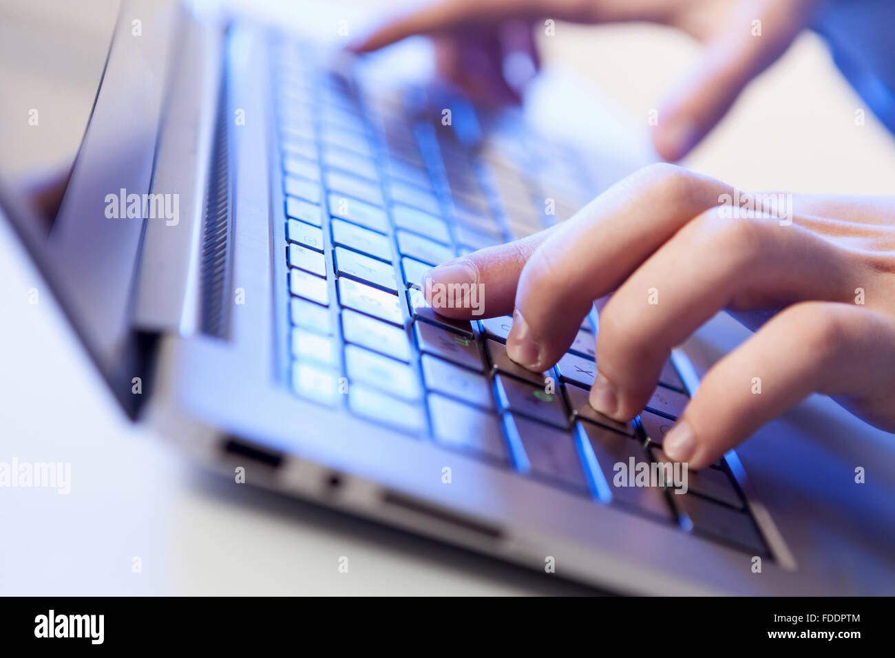 Click! Hands of a man on a keyboard with blue backlighting Stock Photo ...