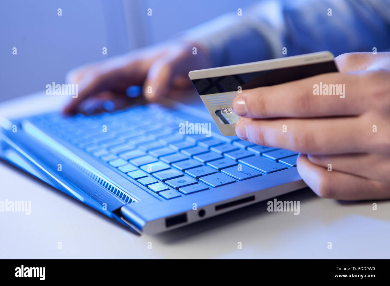 Click! Hands of a man on a keyboard with blue backlighting Stock Photo ...