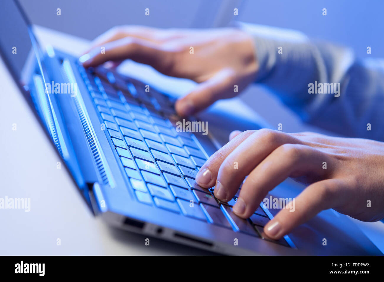 Click! Hands of a man on a keyboard with blue backlighting Stock Photo ...