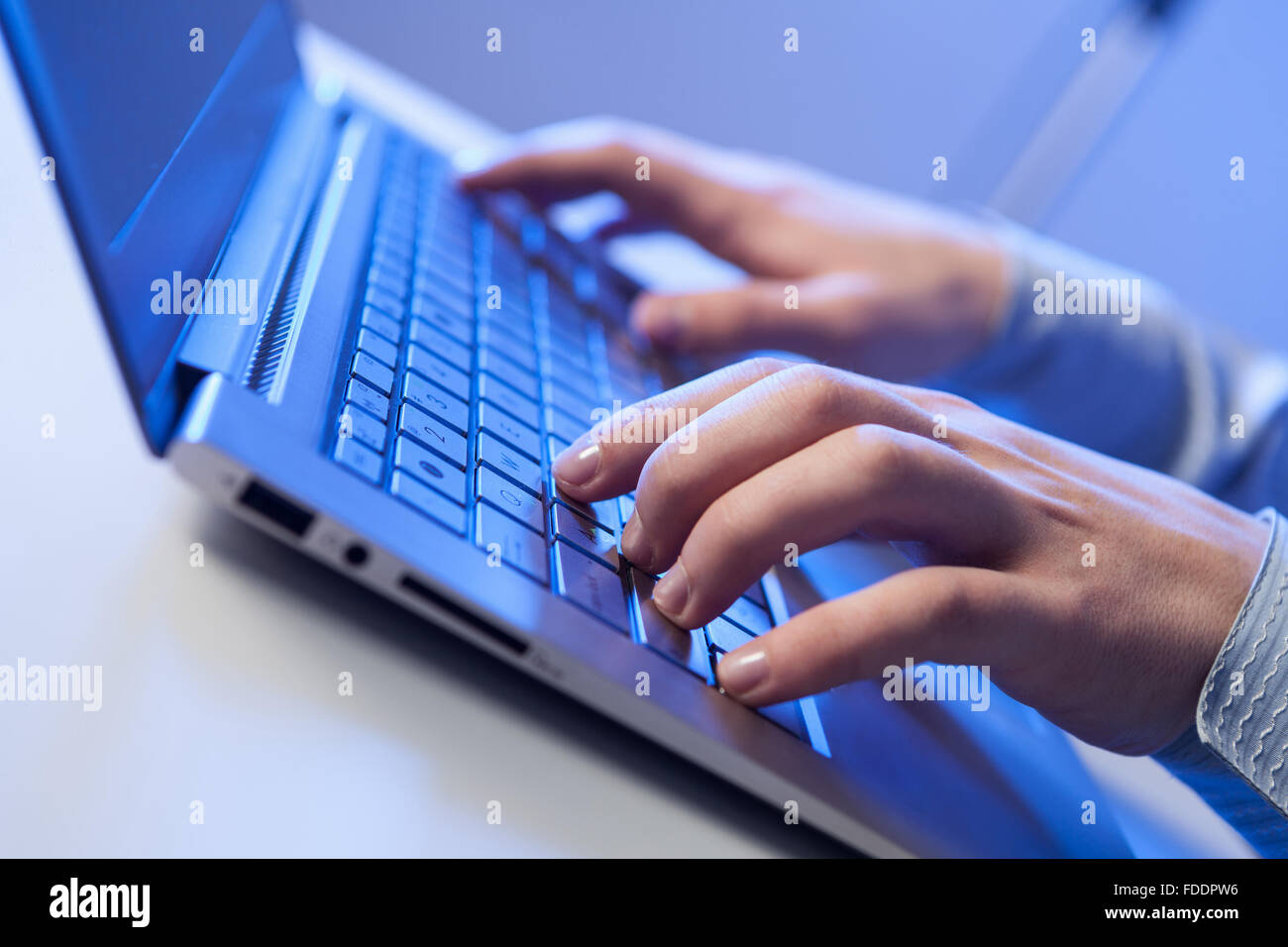 Click! Hands of a man on a keyboard with blue backlighting Stock Photo ...