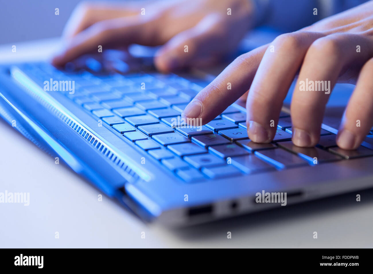 Click! Hands of a man on a keyboard with blue backlighting Stock Photo ...