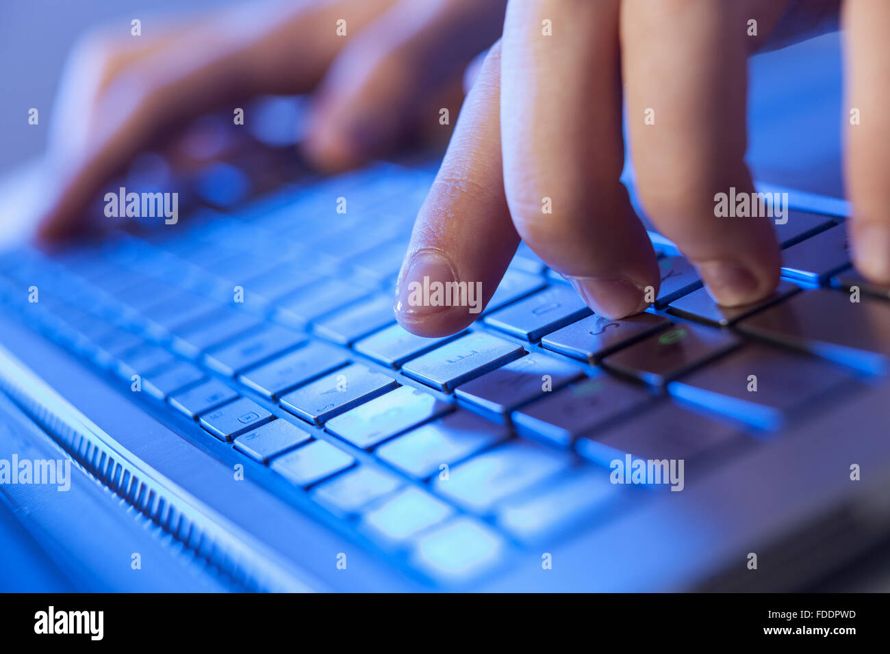 Click! Hands of a man on a keyboard with blue backlighting Stock Photo ...
