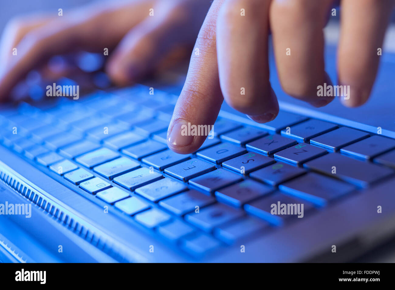 Click! Hands of a man on a keyboard with blue backlighting Stock Photo ...