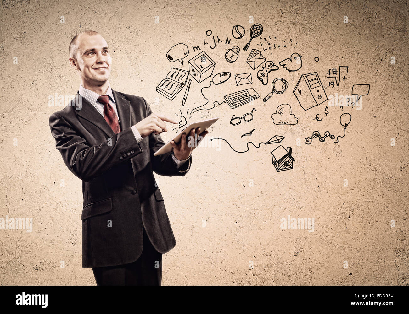 Image of businessman holding ipad. Collage drawings Stock Photo - Alamy