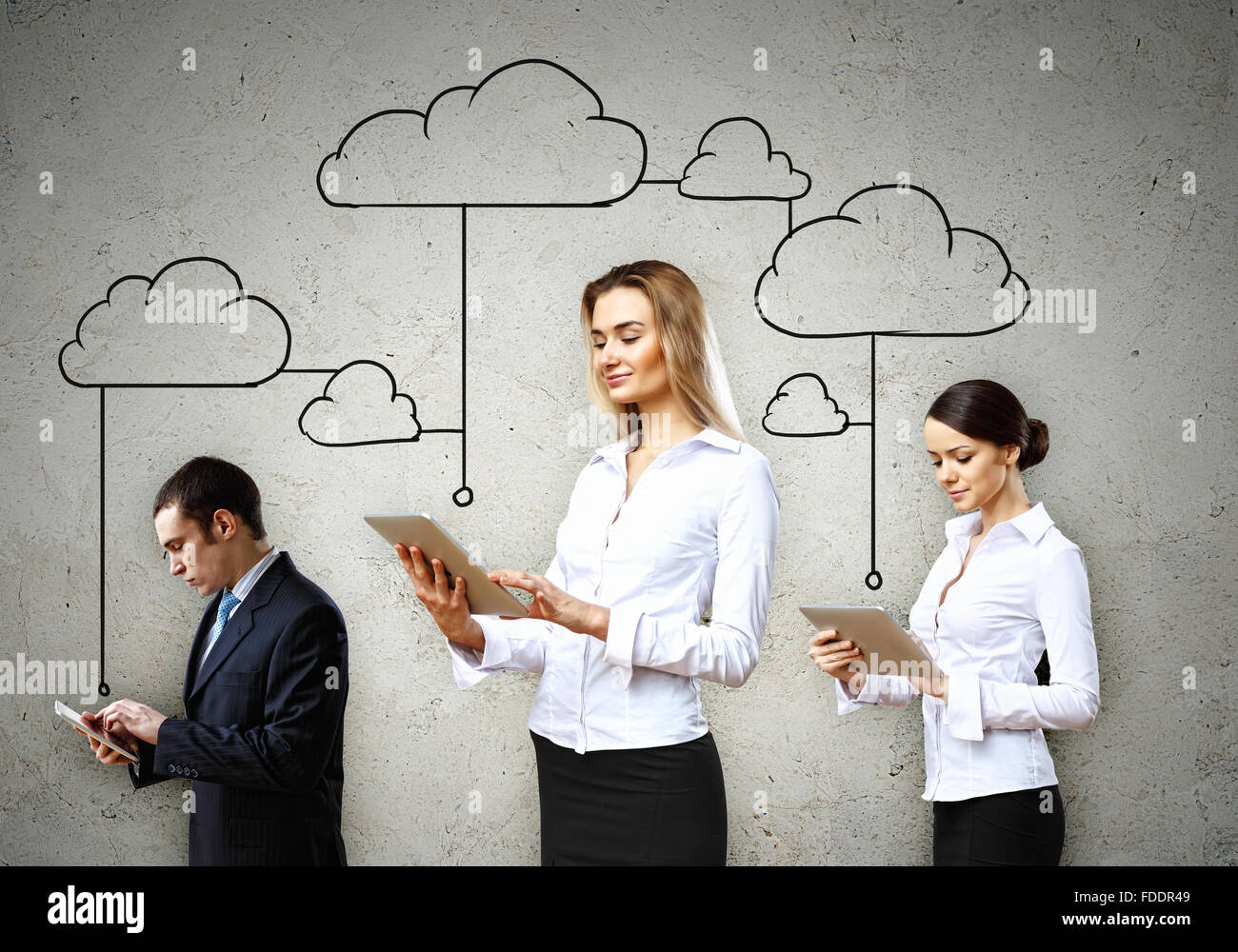 Three young people with tablet pc in hands Stock Photo - Alamy