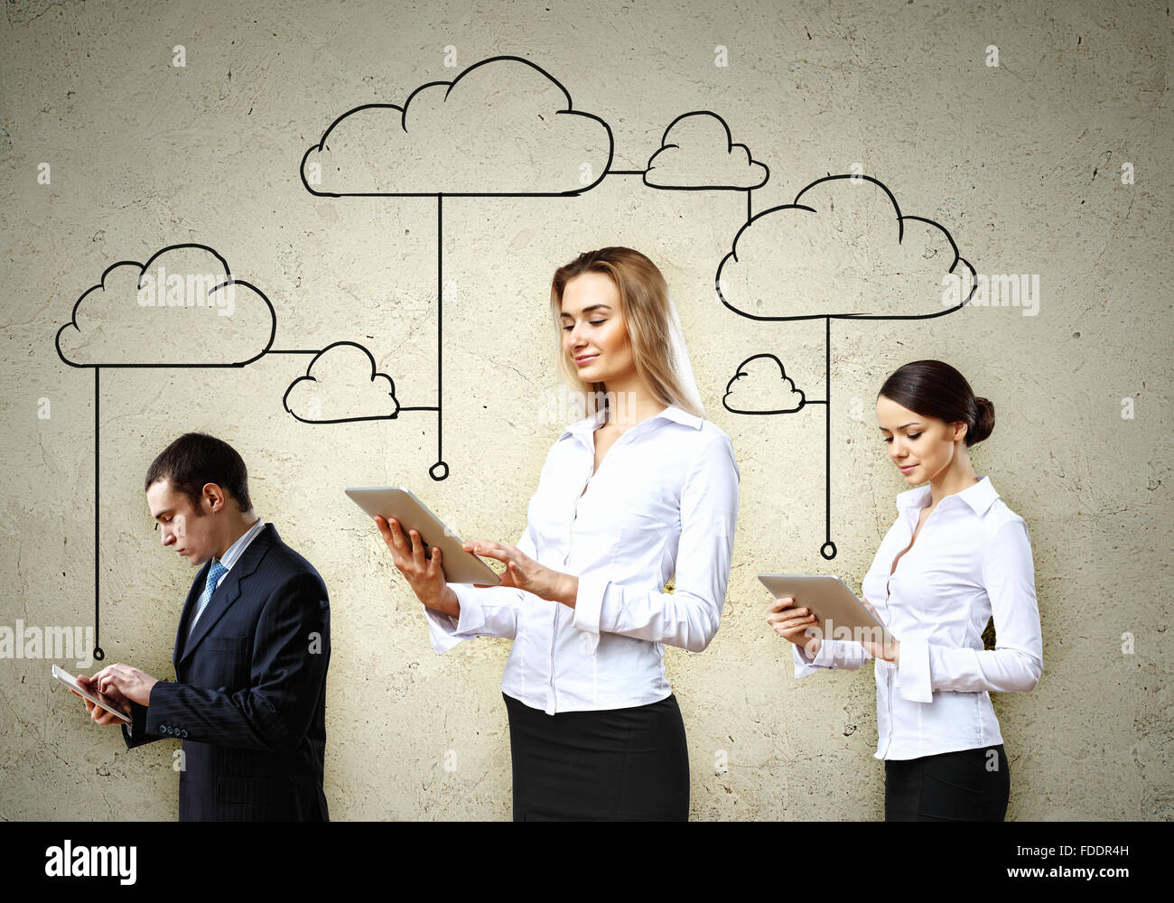 Three young people with tablet pc in hands Stock Photo - Alamy