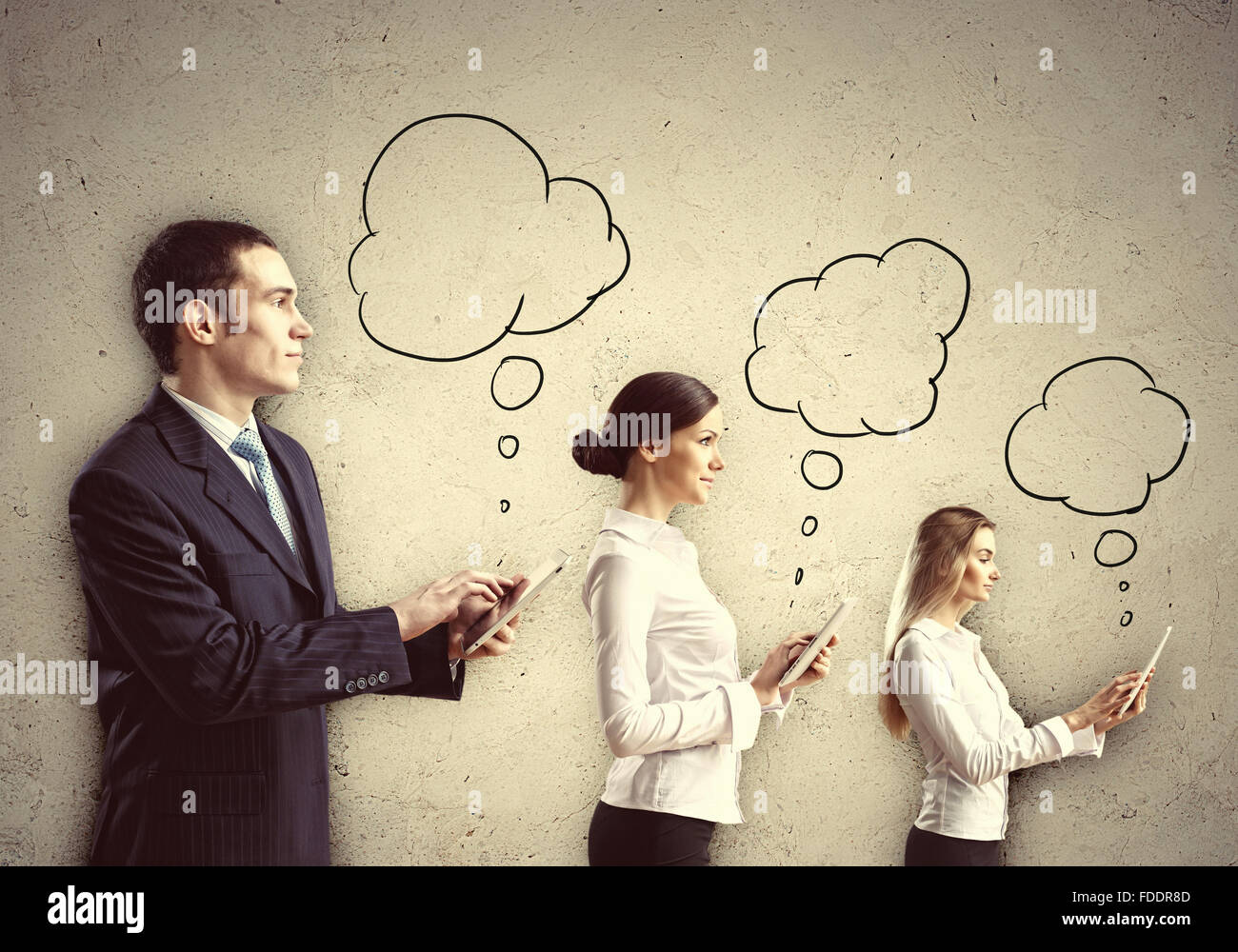 Three young people with tablet pc in hands Stock Photo - Alamy