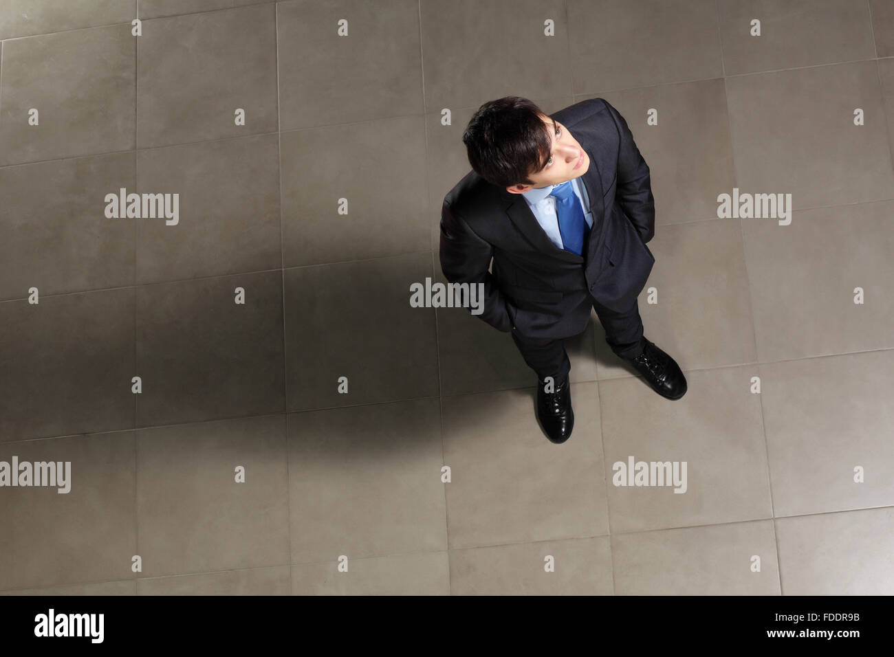 Image of young businessman looking above. Top view Stock Photo - Alamy
