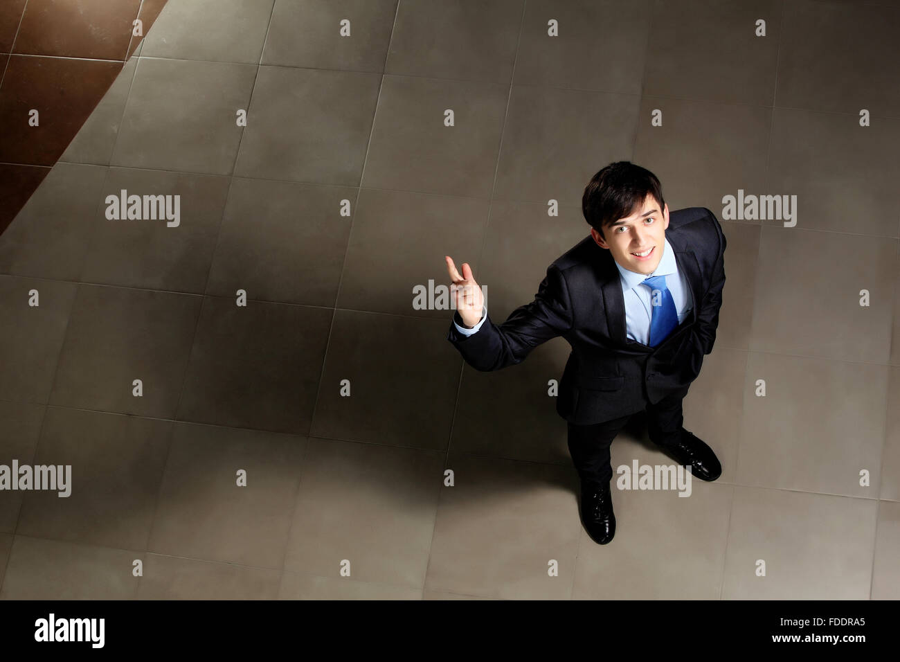 Image of young businessman pointing with his finger up. Top view Stock ...