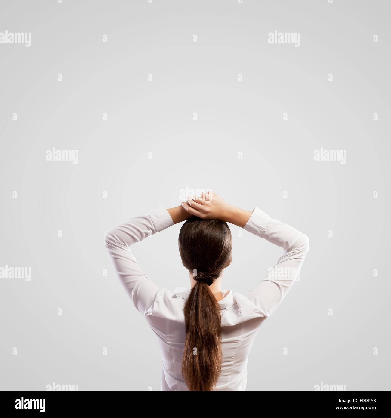 Woman arms crossed above head hi-res stock photography and images - Alamy