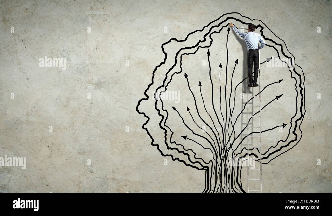 Back view image of businessman drawing graphics on wall Stock Photo - Alamy