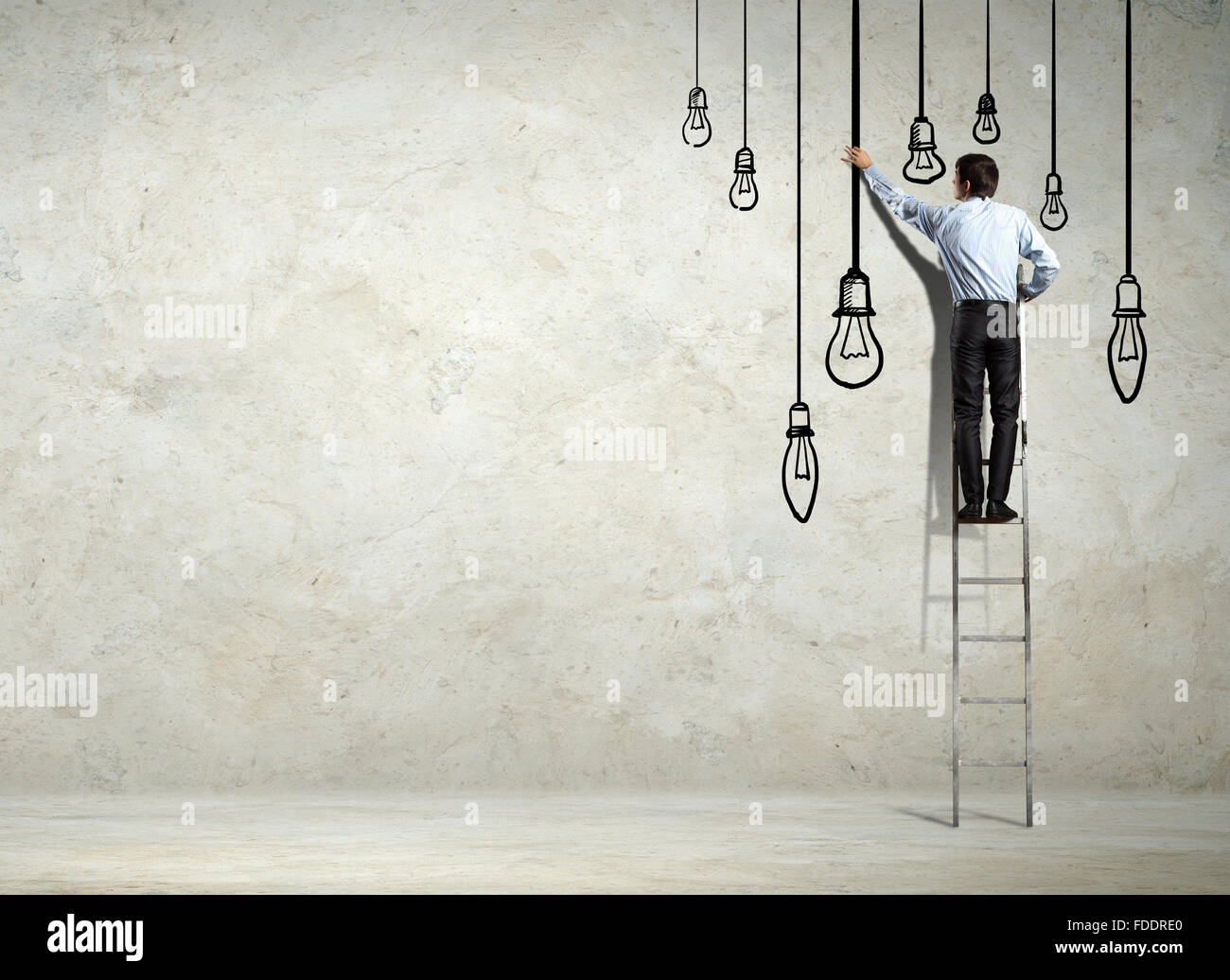 Back view image of businessman drawing graphics on wall Stock Photo - Alamy