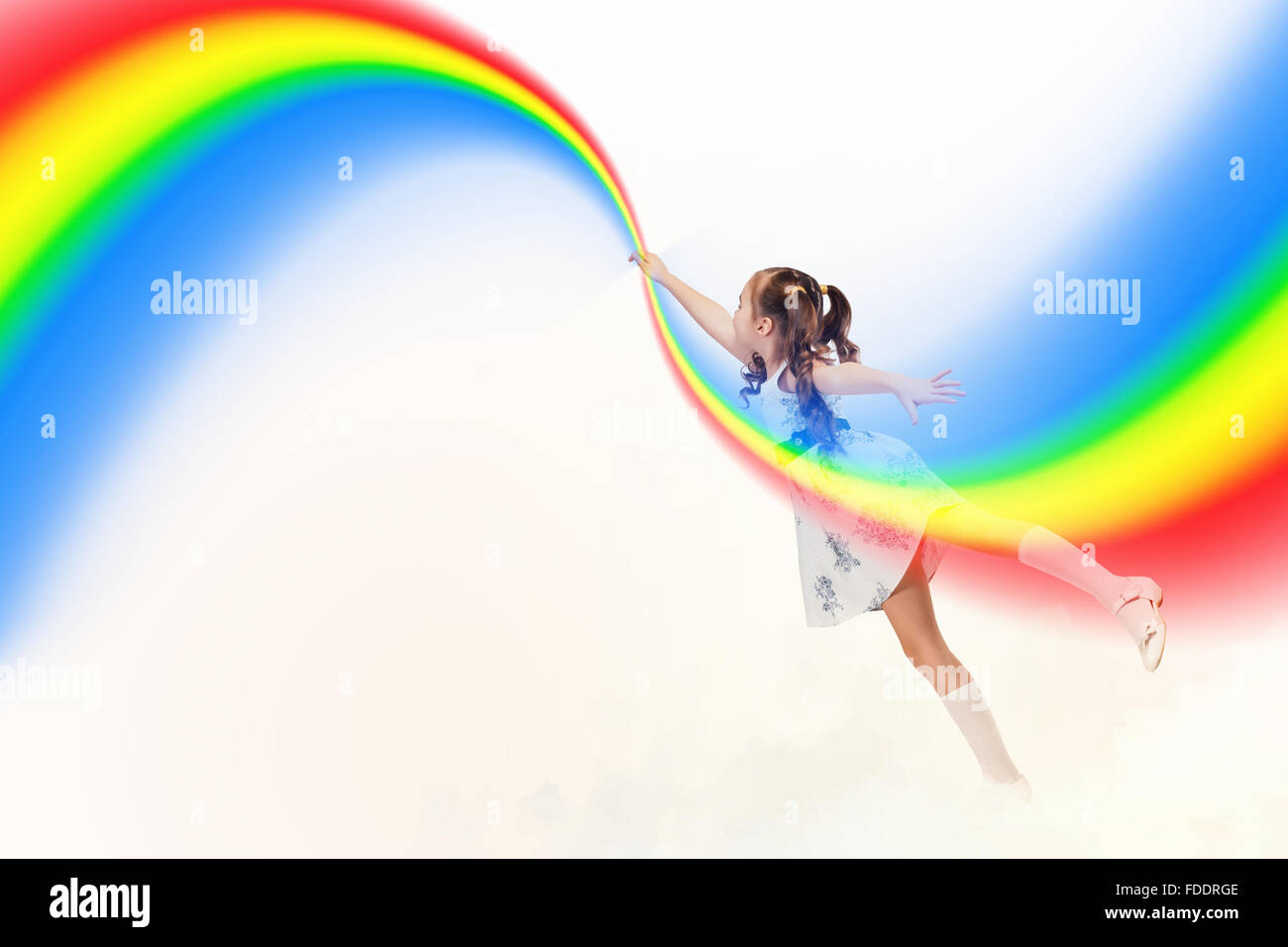 Image of little pretty girl drawing rainbow with finger Stock Photo - Alamy