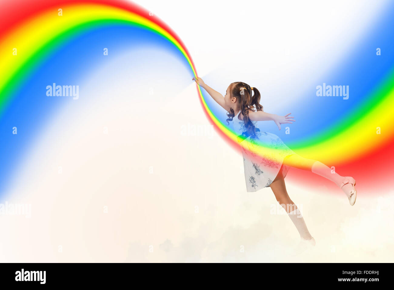 Image of little pretty girl drawing rainbow with finger Stock Photo - Alamy