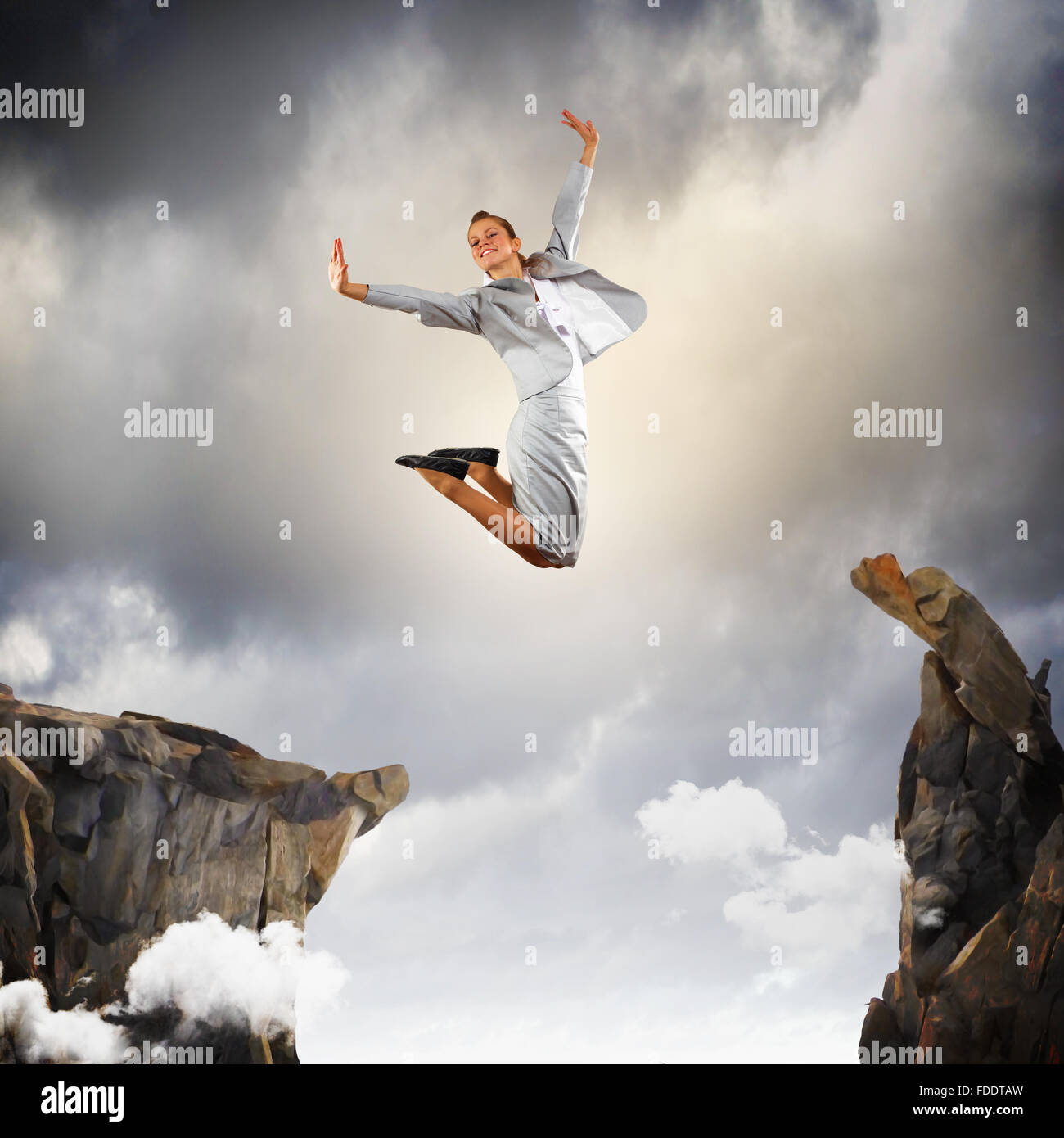 Image of young businesswoman jumping over gap Stock Photo - Alamy