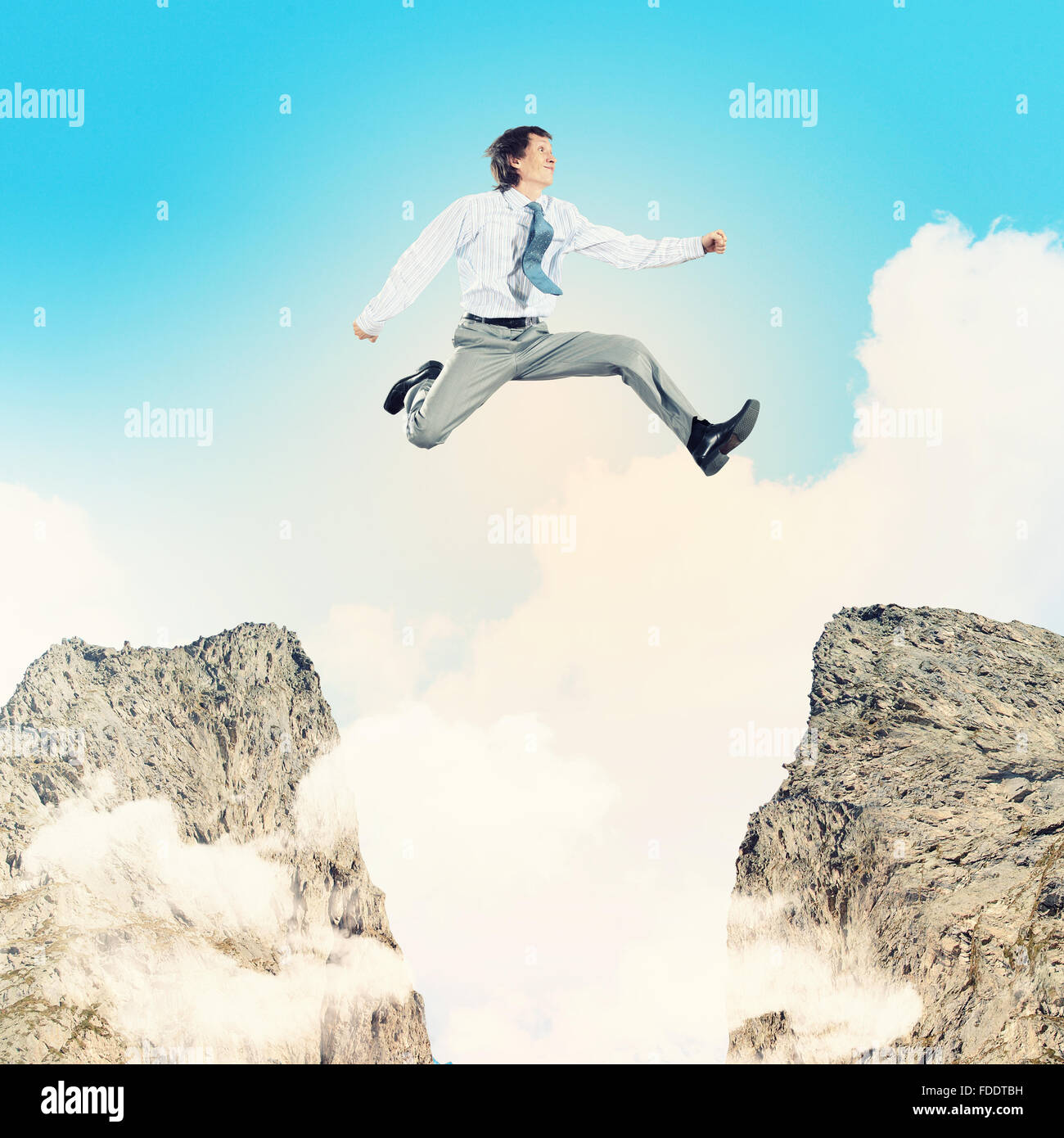 Image of young businessman jumping over gap Stock Photo - Alamy