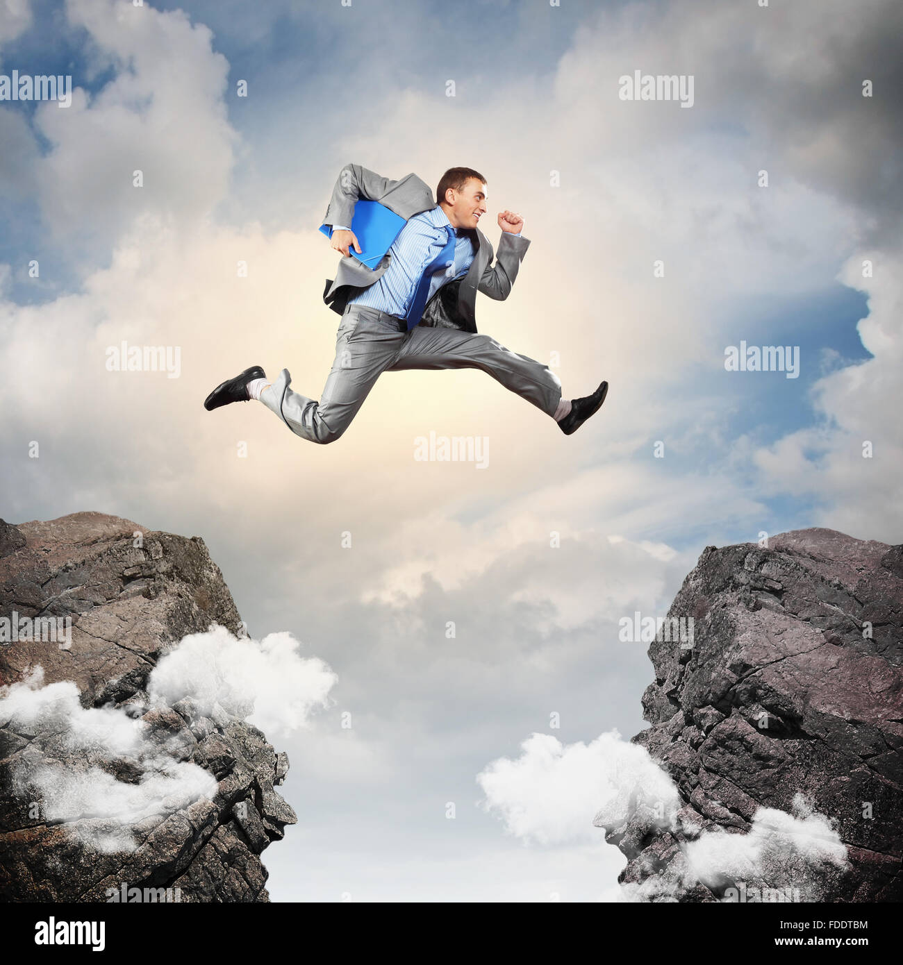 Image of young businessman jumping over gap Stock Photo - Alamy