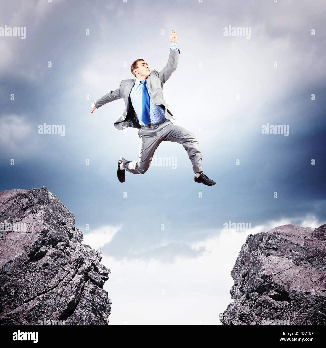 Image of young businessman jumping over gap Stock Photo - Alamy