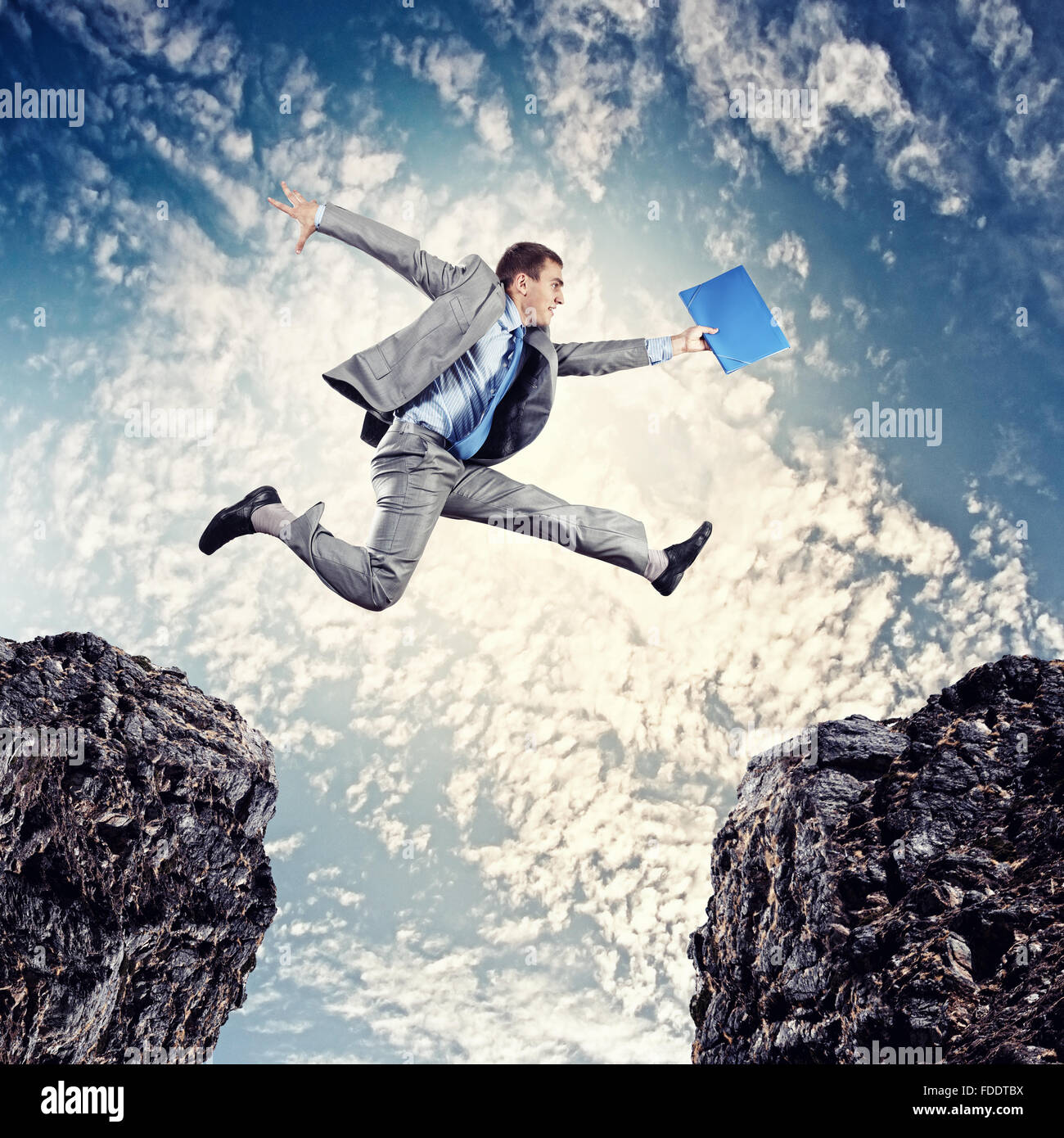 Image of young businessman jumping over gap Stock Photo - Alamy