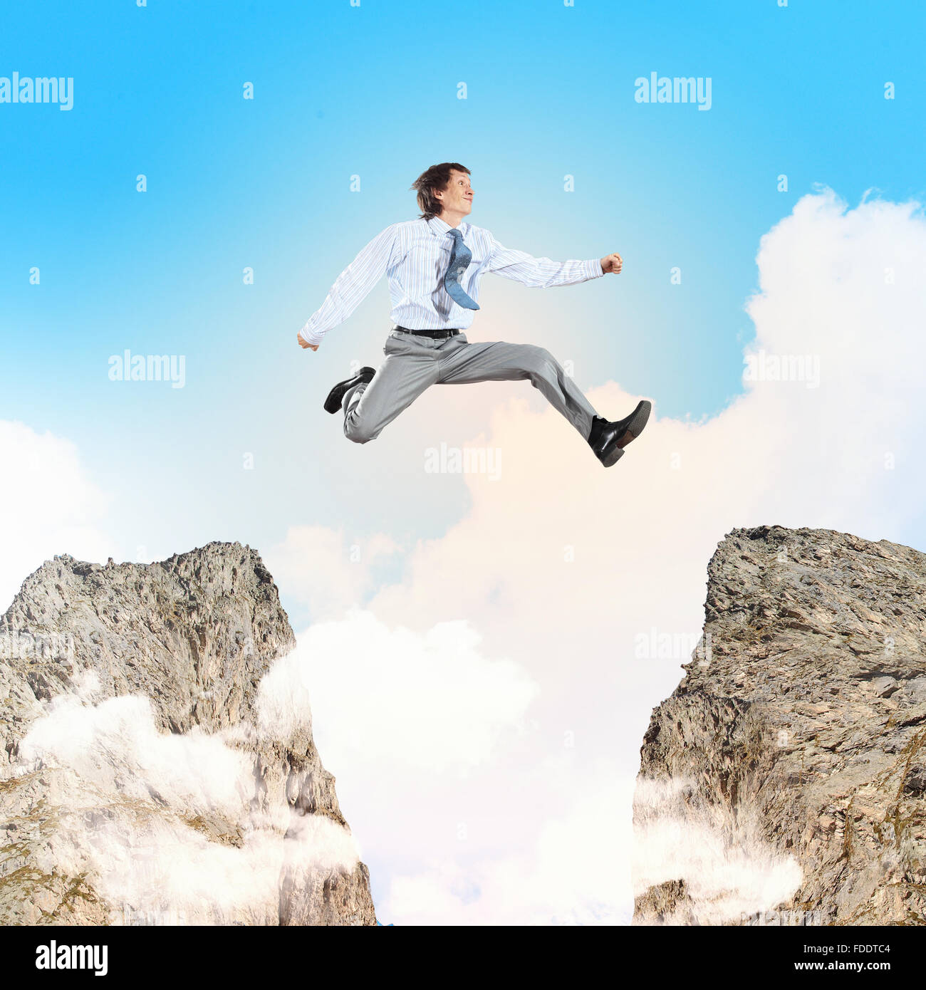 Image of young businessman jumping over gap Stock Photo - Alamy