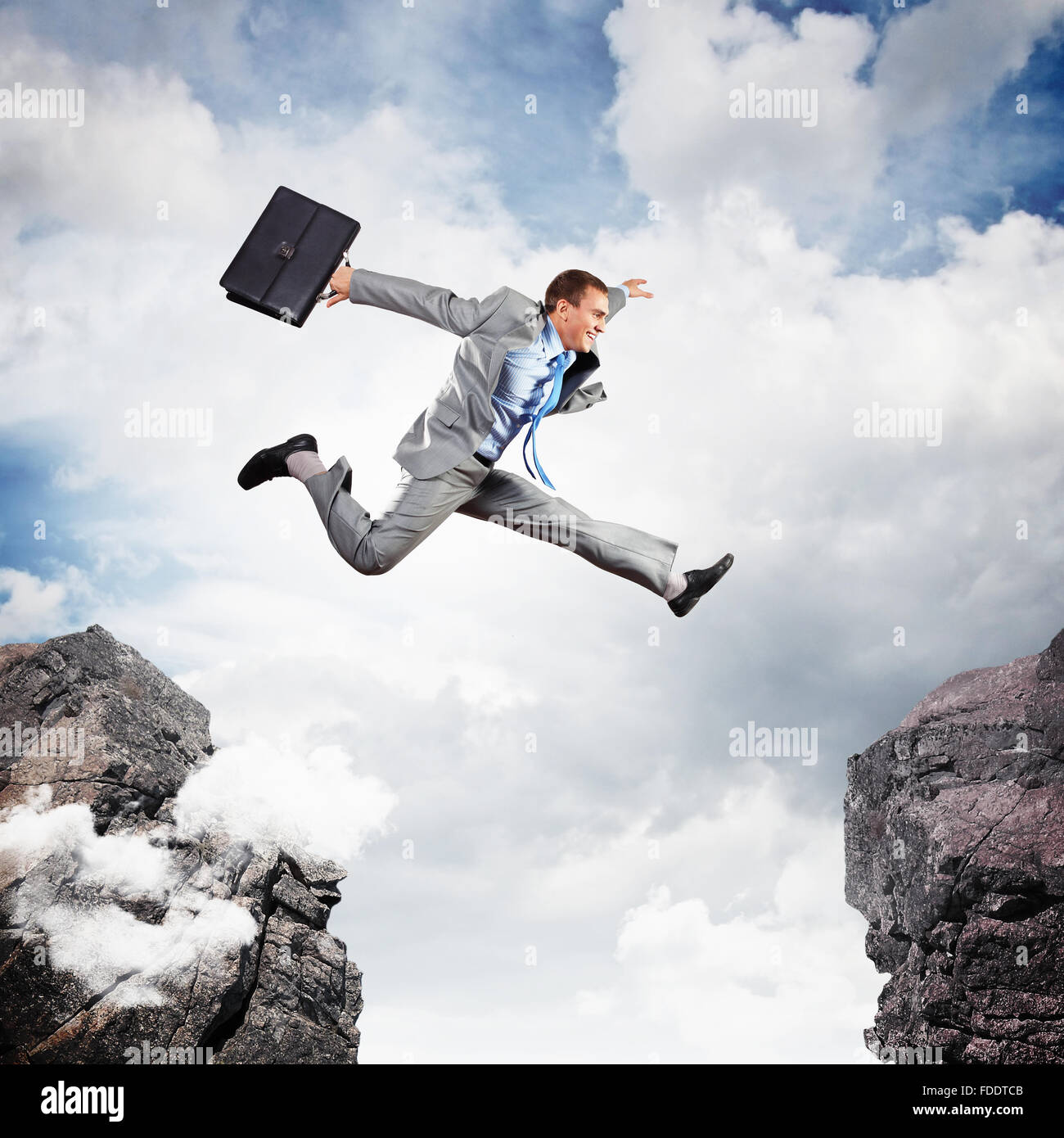 Image of young businessman jumping over gap Stock Photo - Alamy