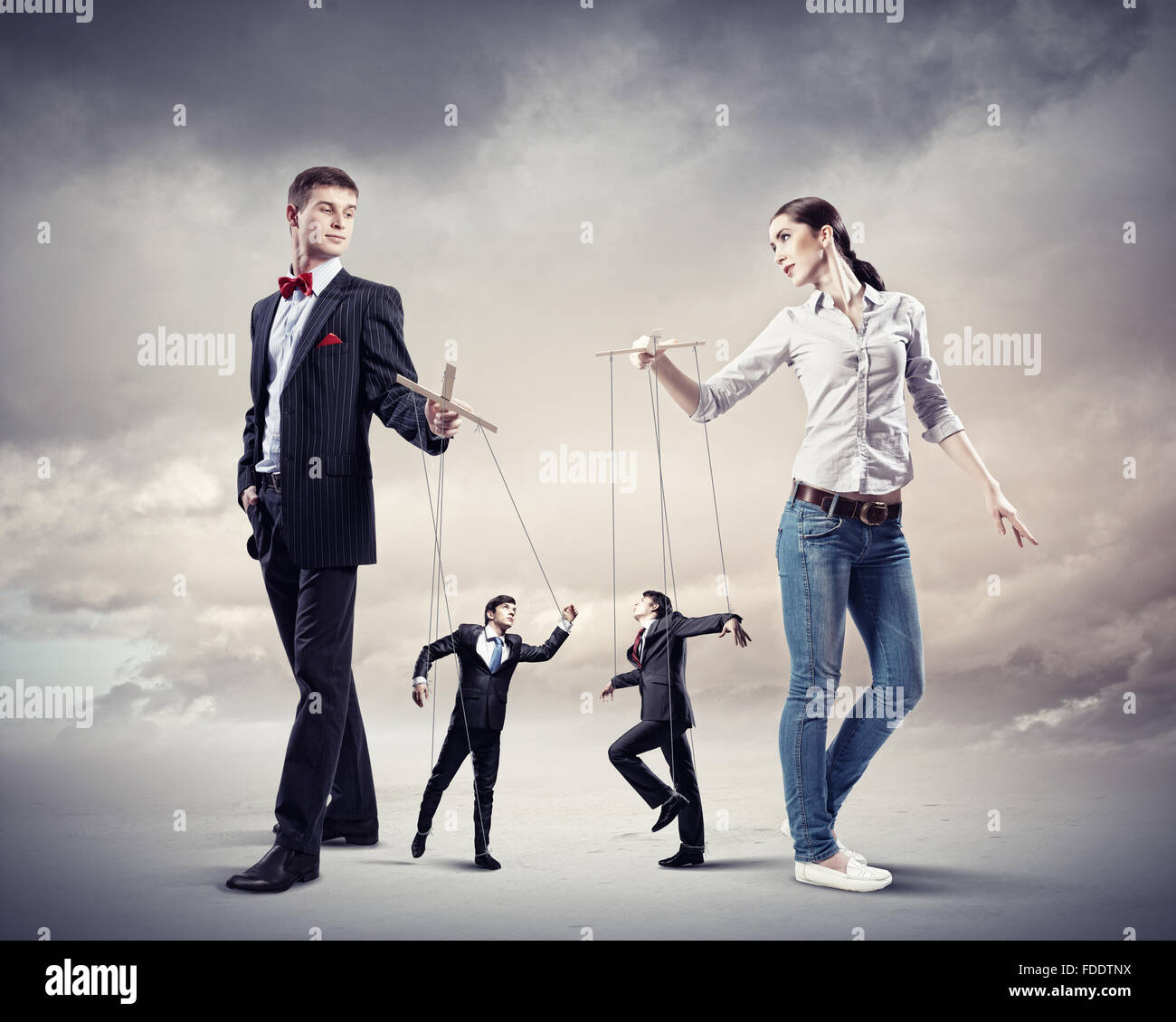 Image of man and woman with marionette puppets Stock Photo - Alamy