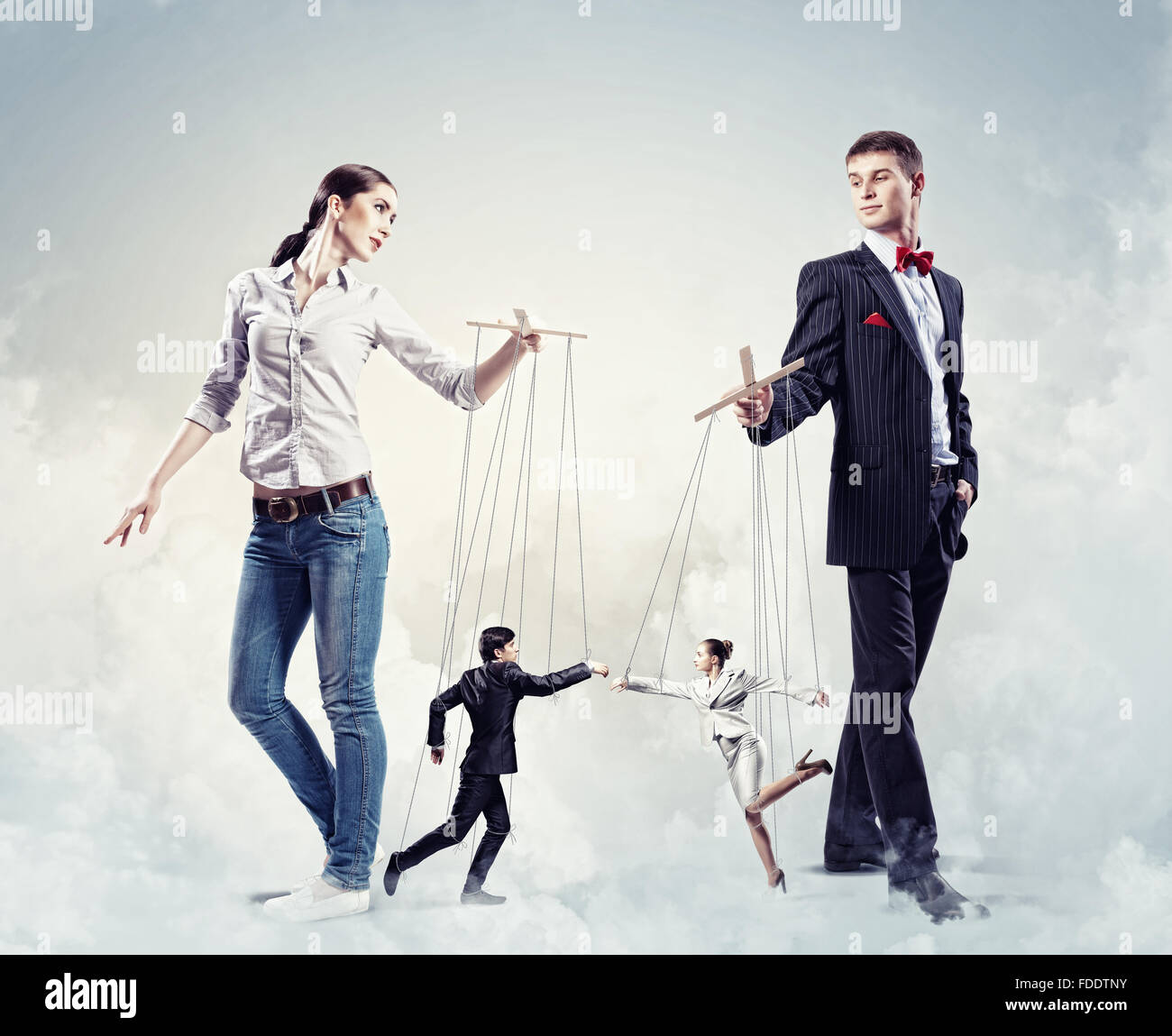 Image of man and woman with marionette puppets Stock Photo - Alamy