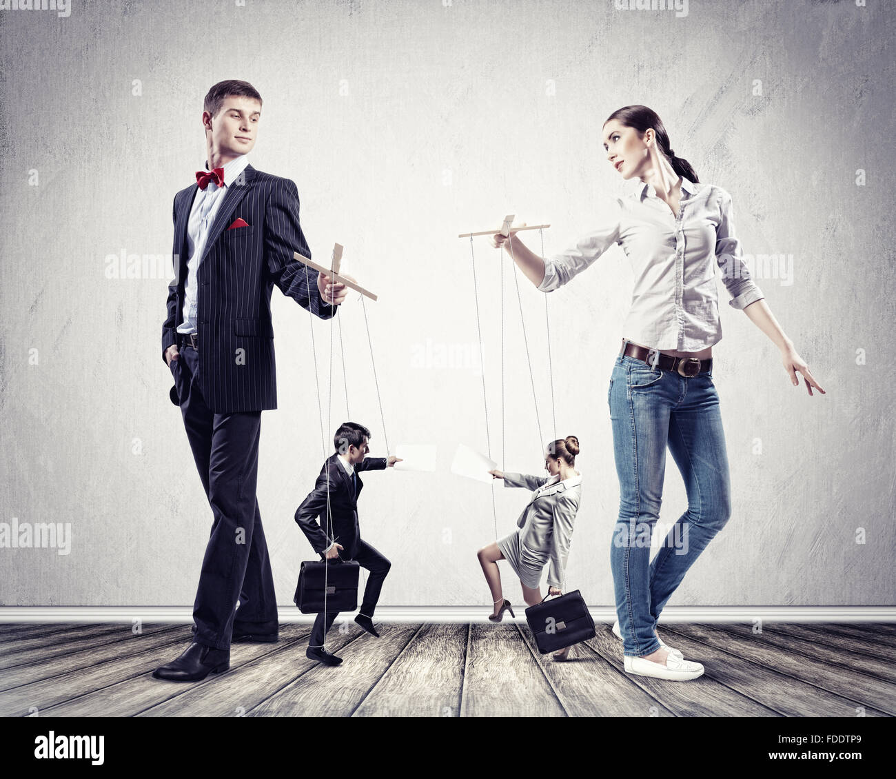 Image of man and woman with marionette puppets Stock Photo - Alamy