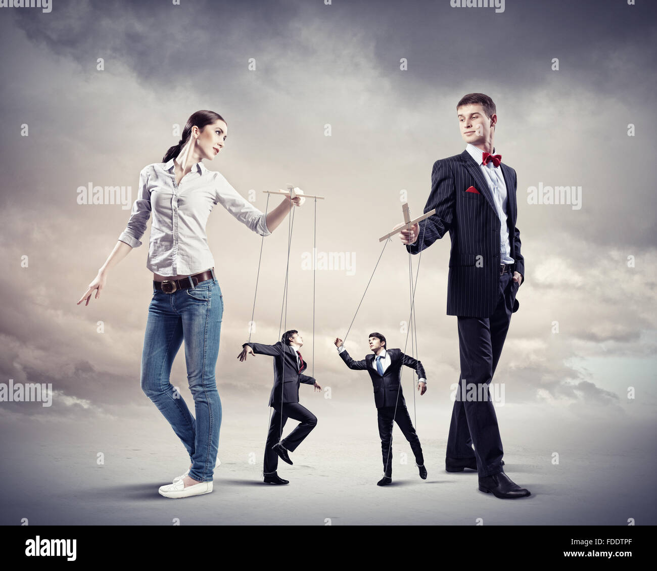 Image of man and woman with marionette puppets Stock Photo - Alamy