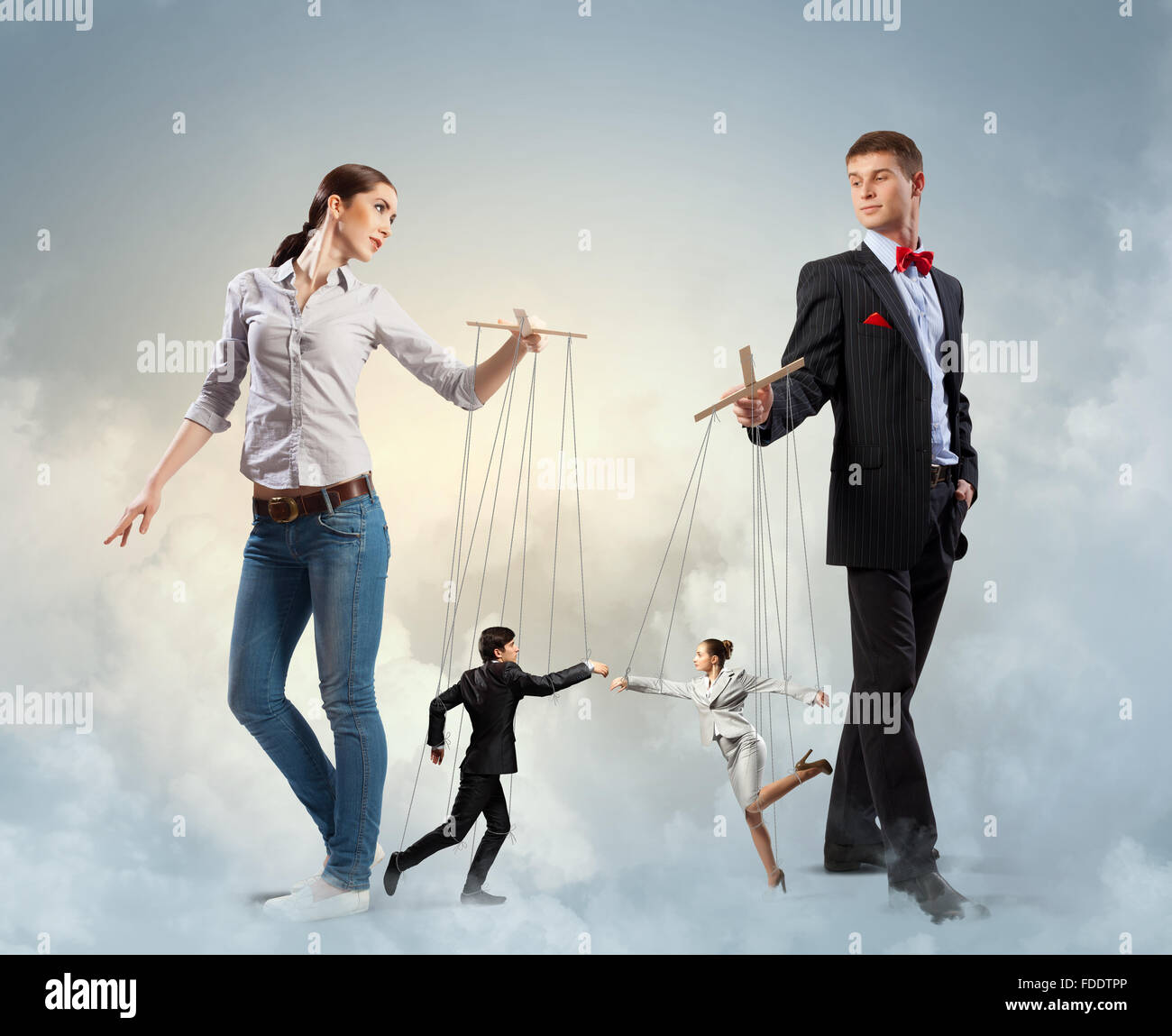 Image of man and woman with marionette puppets Stock Photo - Alamy