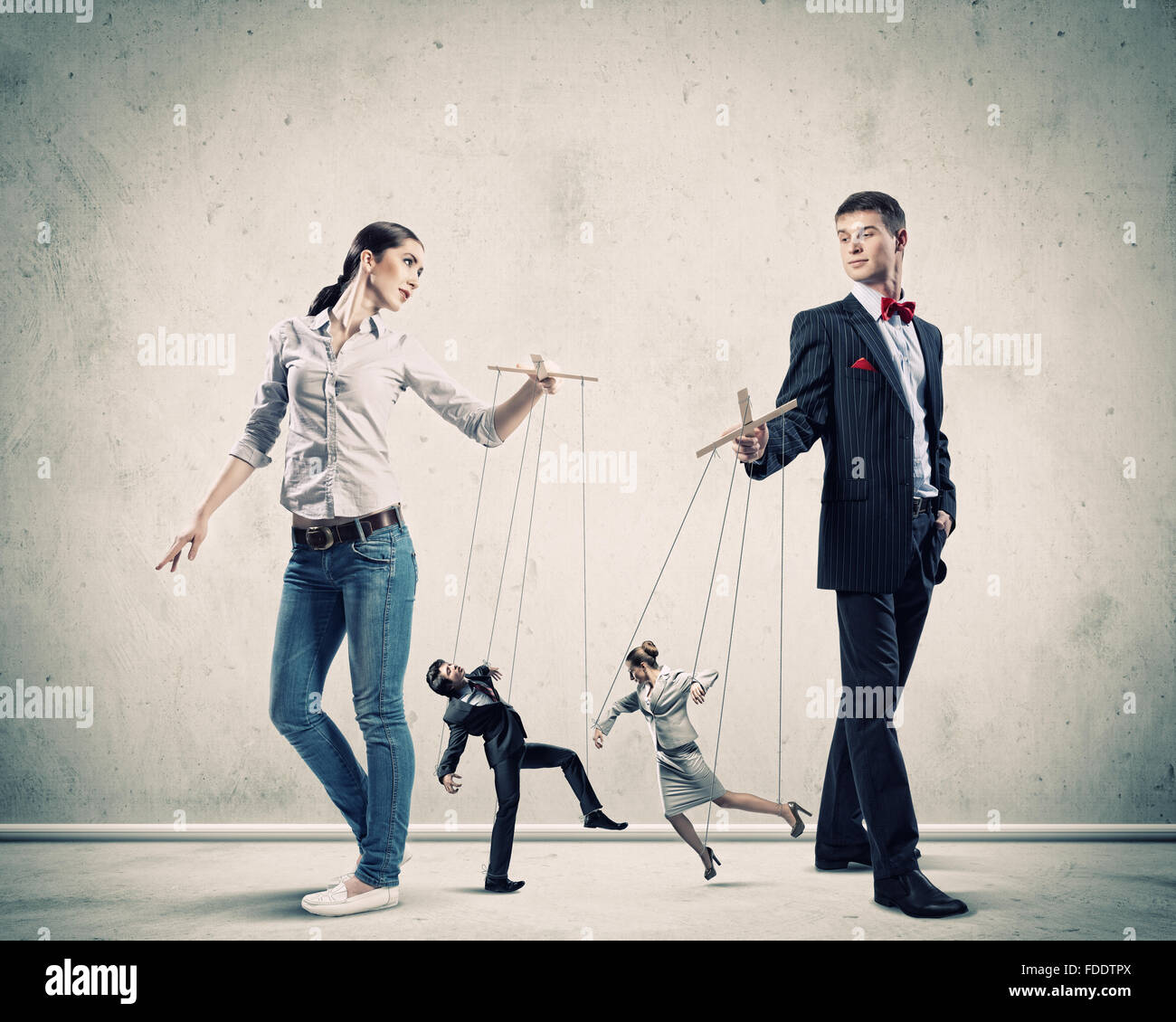 Image of man and woman with marionette puppets Stock Photo - Alamy