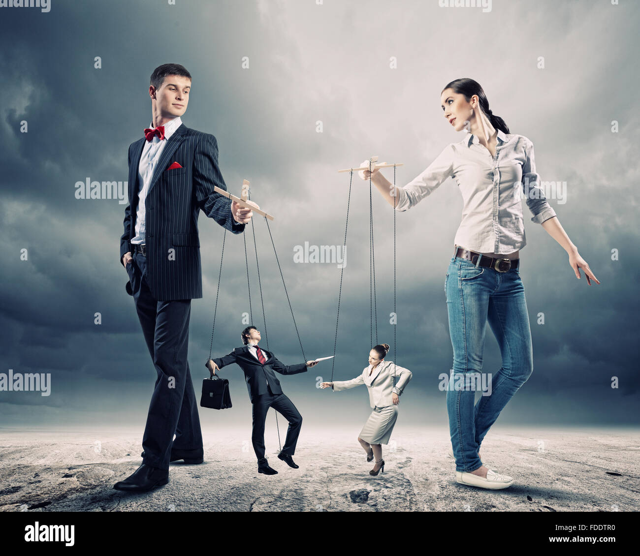 Image of man and woman with marionette puppets Stock Photo - Alamy