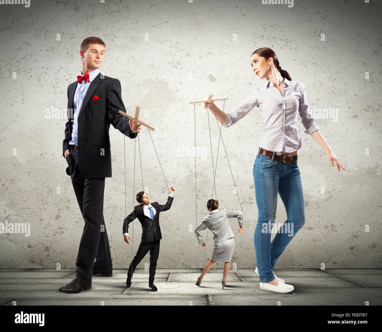 Image of man and woman with marionette puppets Stock Photo - Alamy