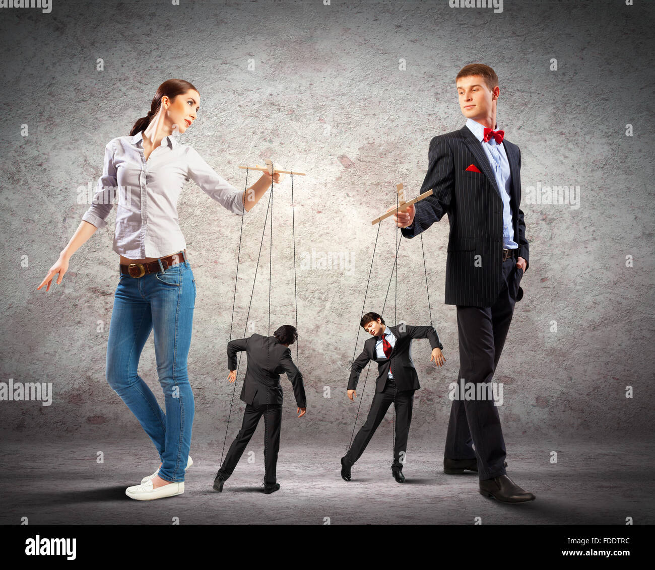 Image of man and woman with marionette puppets Stock Photo - Alamy