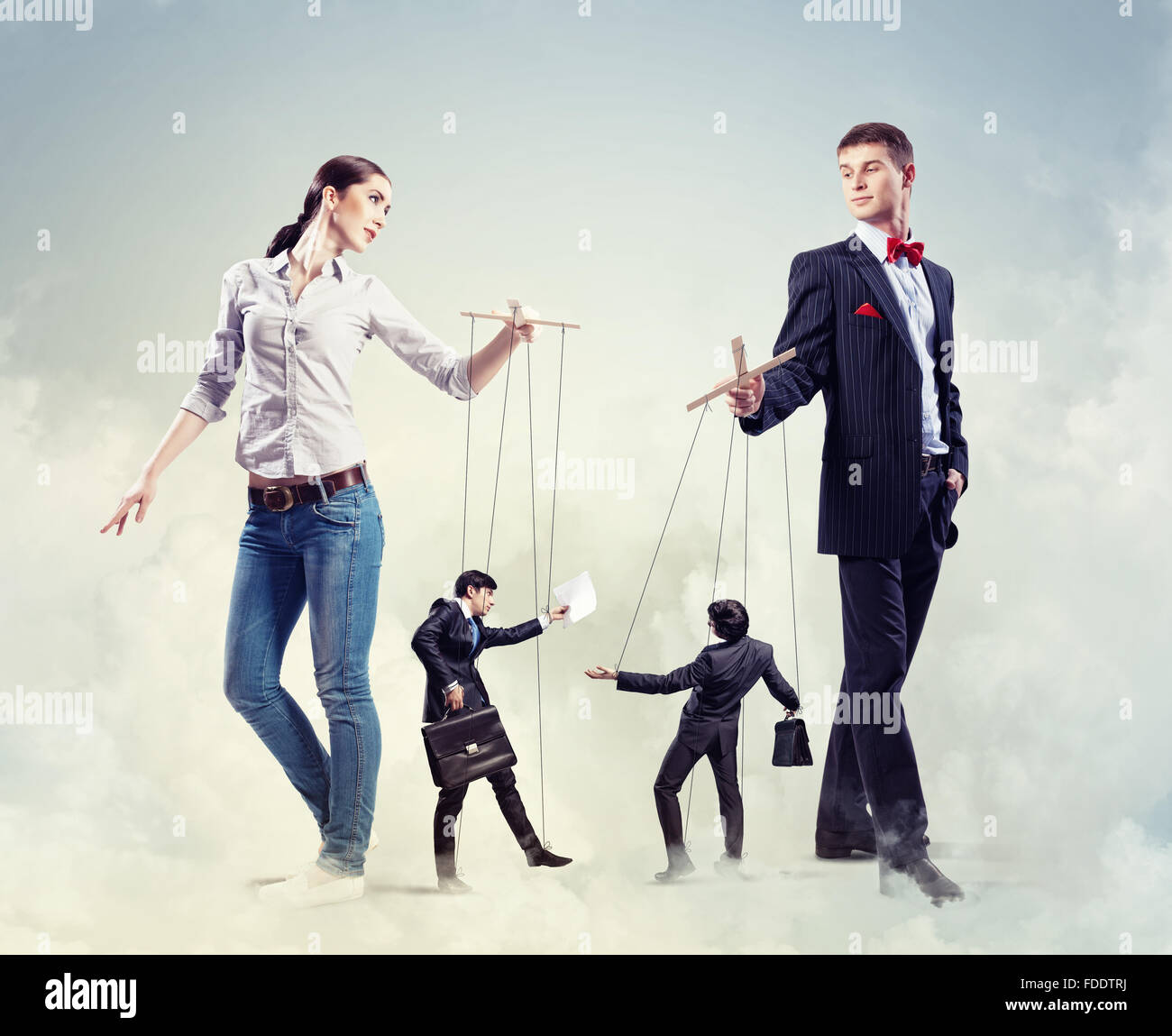 Image of man and woman with marionette puppets Stock Photo - Alamy