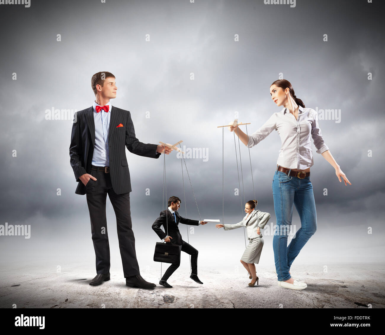 Image of man and woman with marionette puppets Stock Photo - Alamy