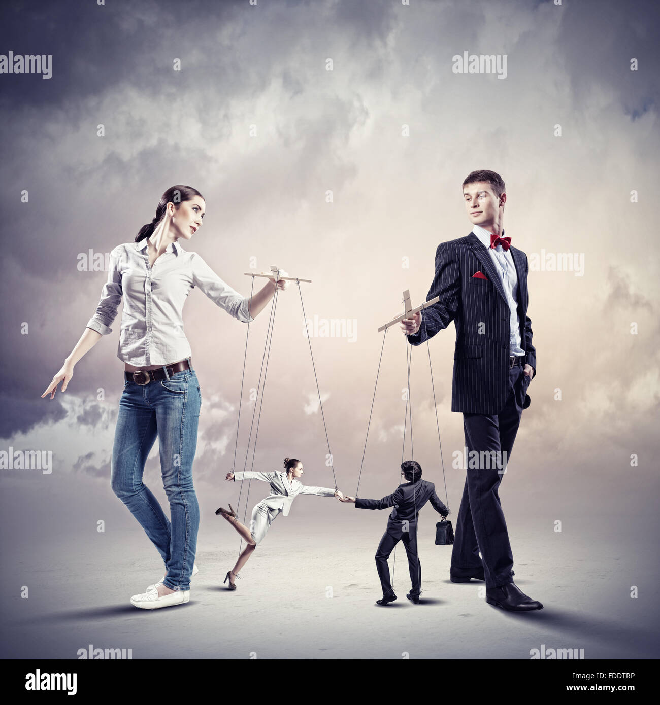 Image of man and woman with marionette puppets Stock Photo - Alamy
