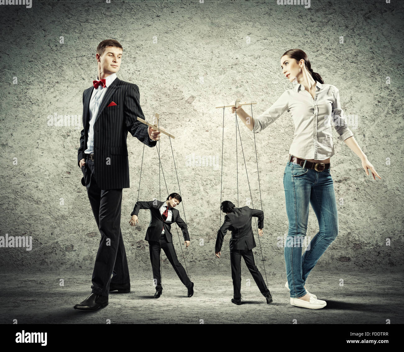 Image of man and woman with marionette puppets Stock Photo - Alamy