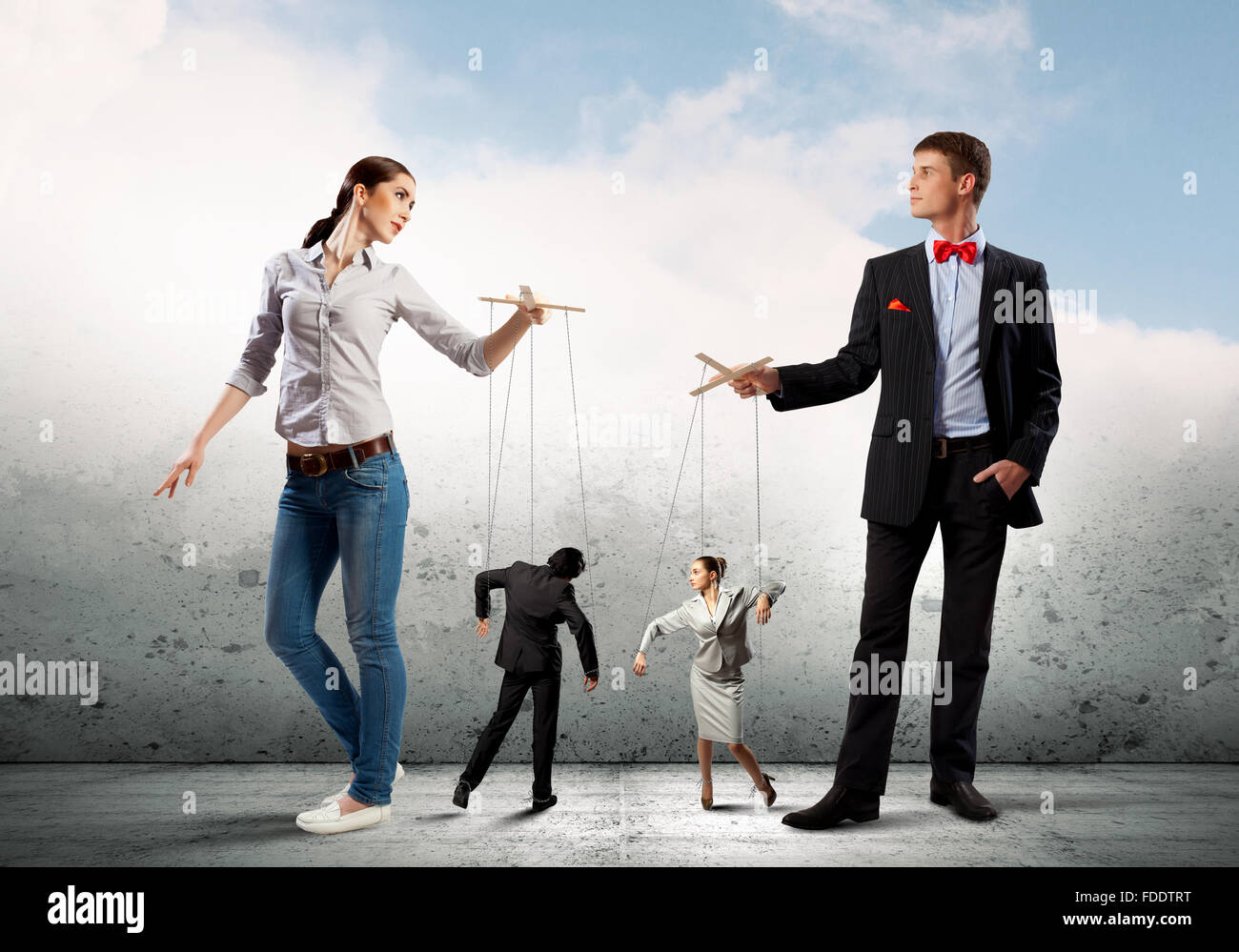 Image of man and woman with marionette puppets Stock Photo - Alamy