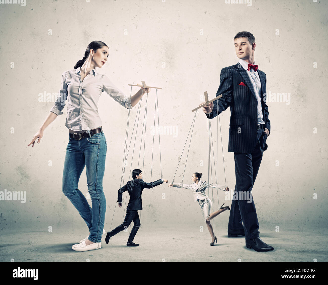 Image of man and woman with marionette puppets Stock Photo - Alamy