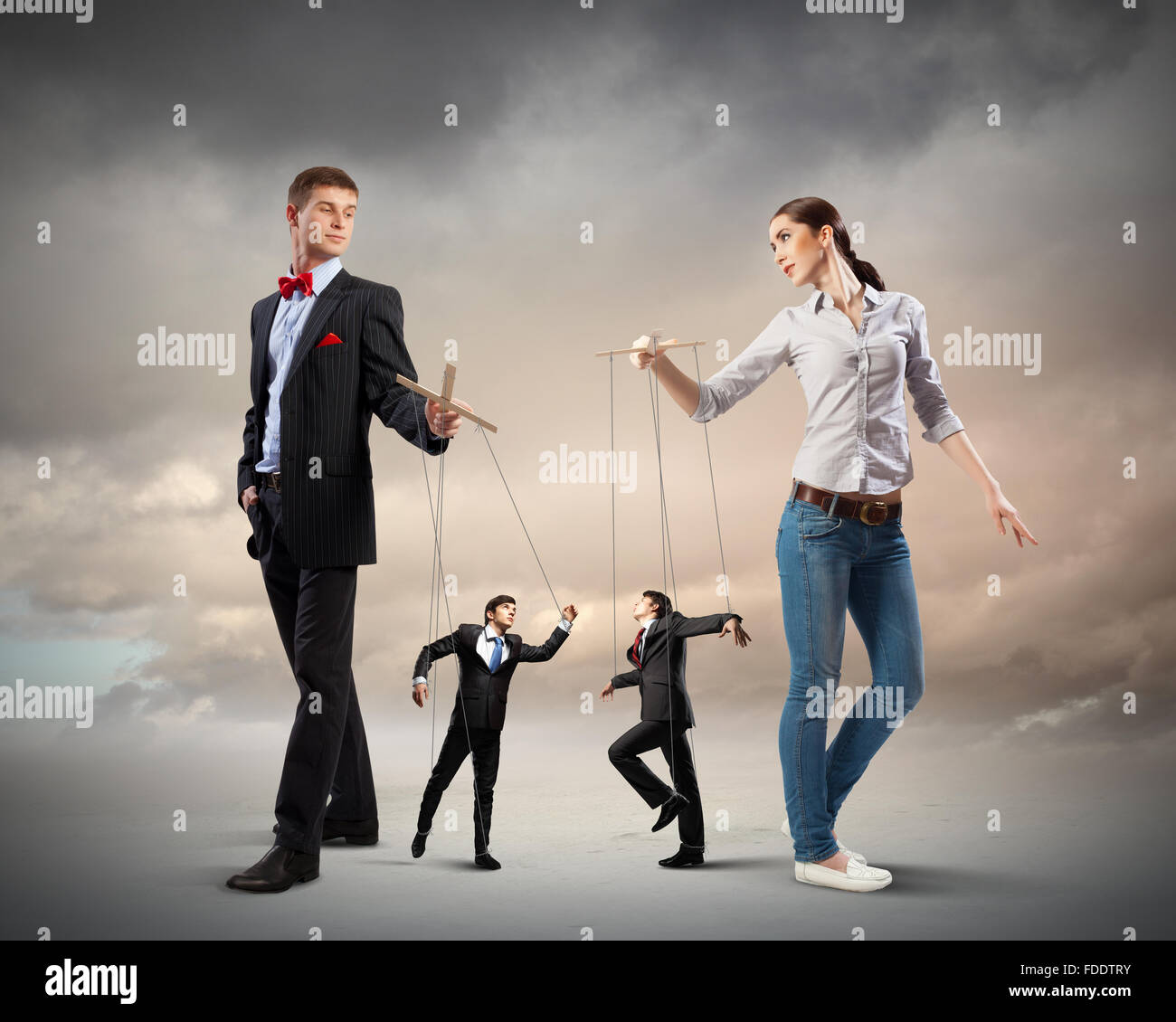 Image of man and woman with marionette puppets Stock Photo - Alamy