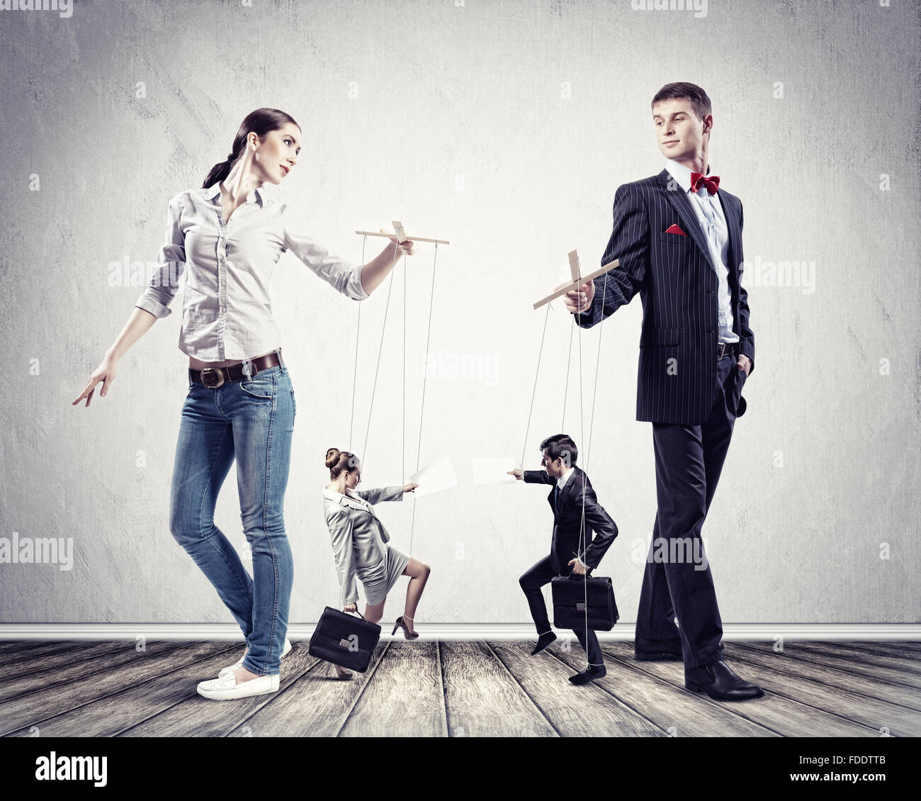 Image of man and woman with marionette puppets Stock Photo - Alamy
