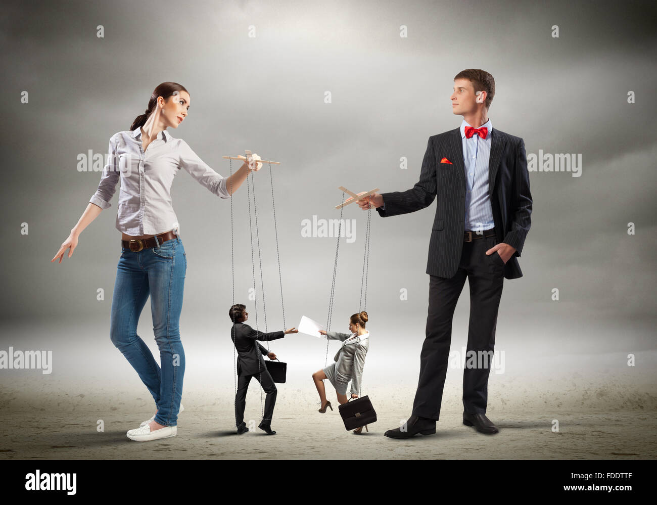 Image of man and woman with marionette puppets Stock Photo - Alamy