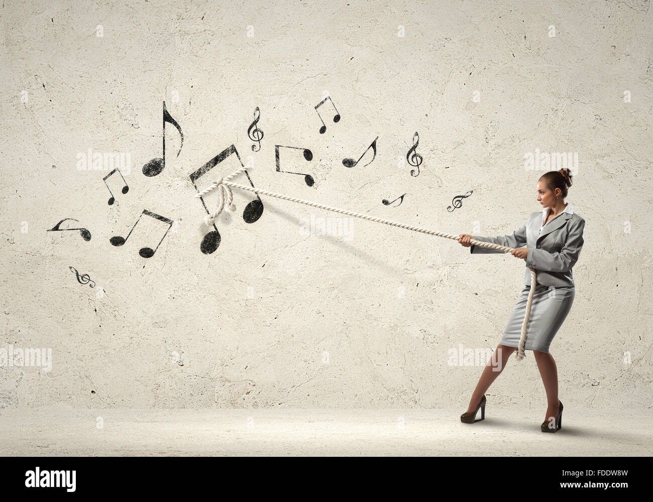 Image of attractive businesswoman pulling rope with note symbol Stock ...