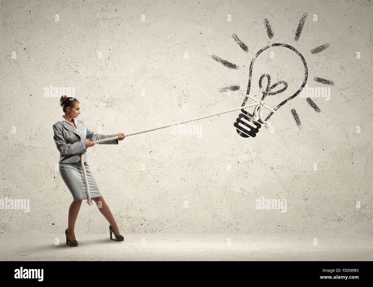 Image of attractive businesswoman pulling rope with idea symbol Stock ...