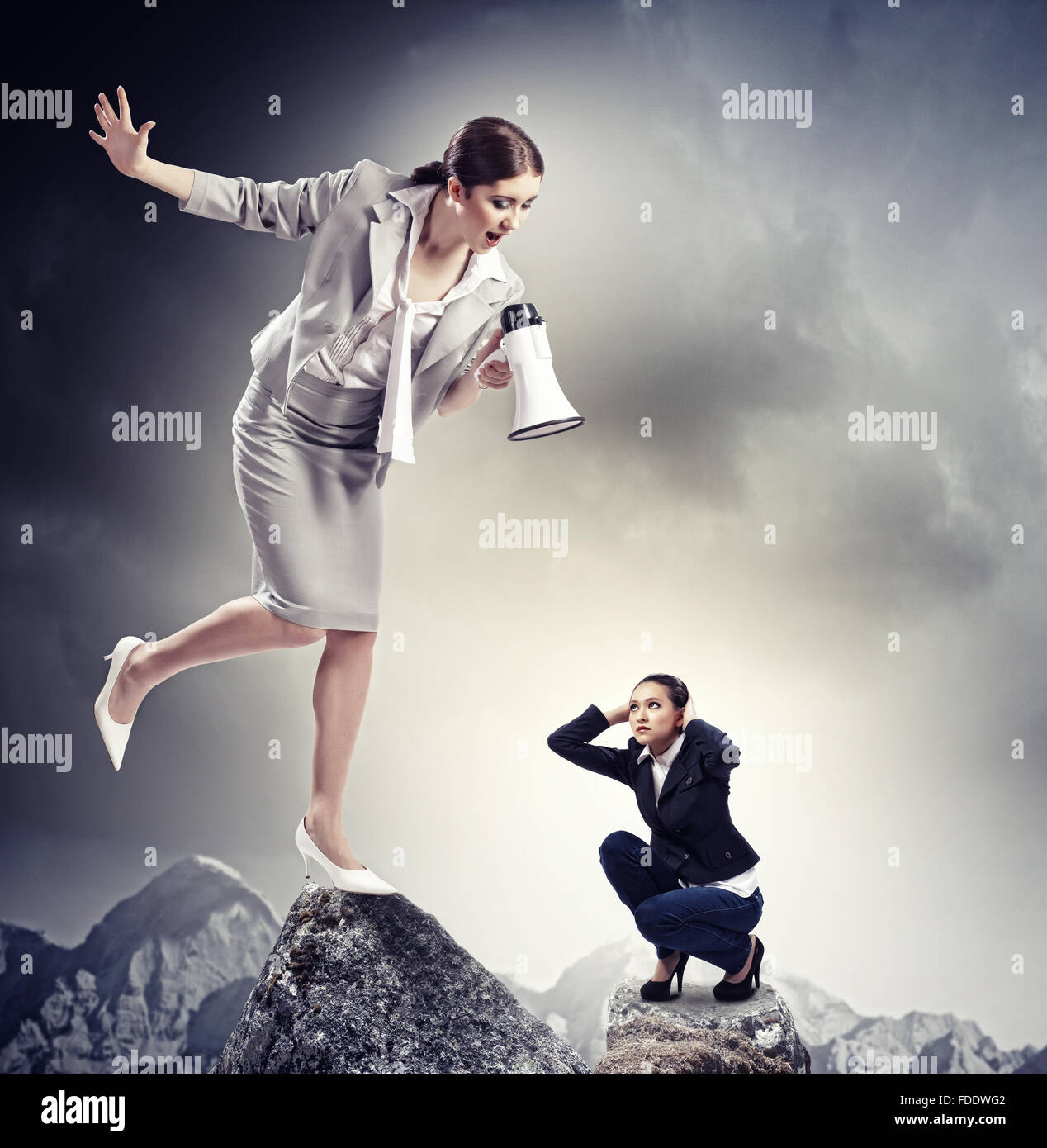 Angry businesswoman with megaphone shouting at colleague Stock Photo ...