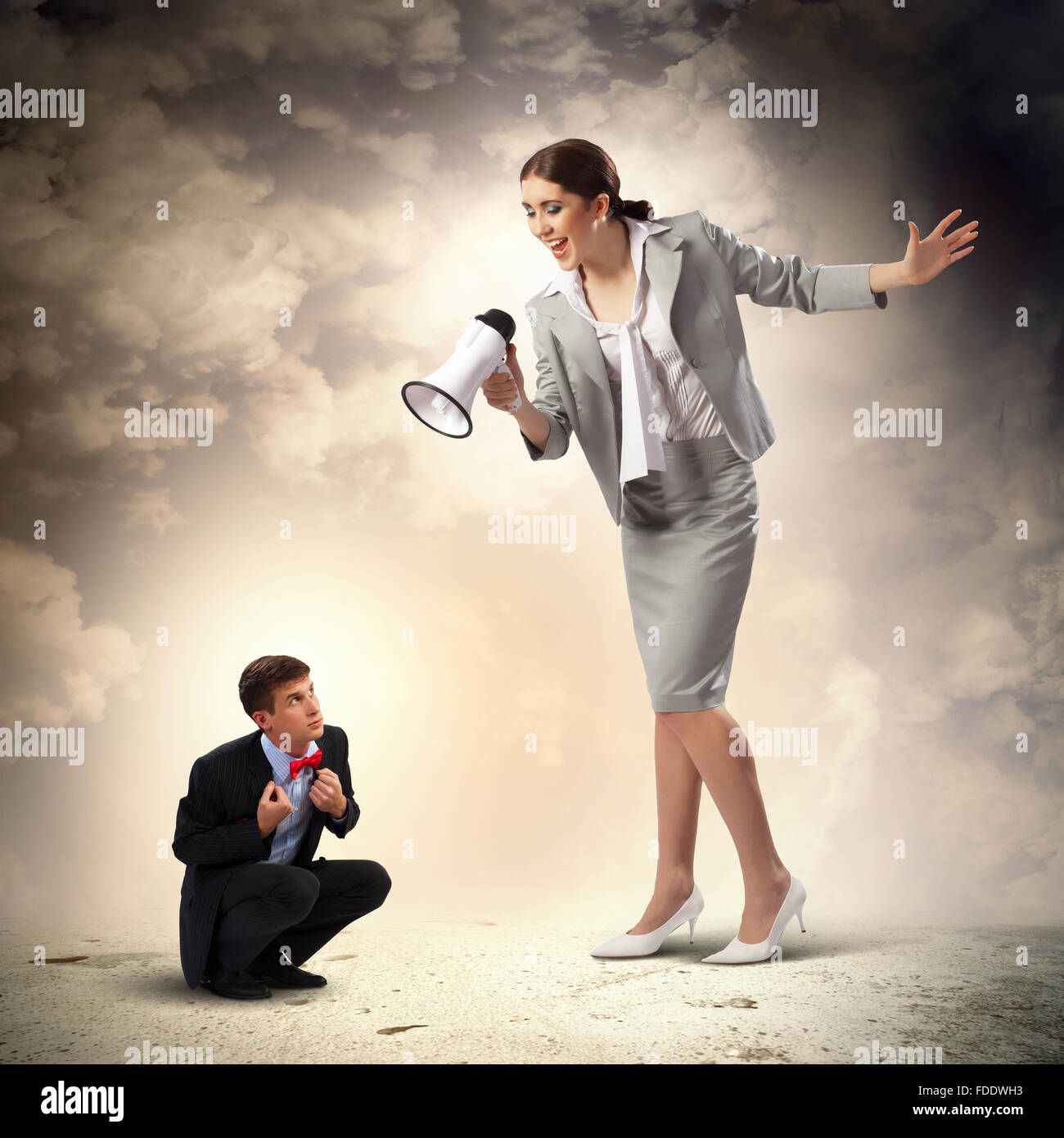 Angry businesswoman with megaphone shouting at colleague Stock Photo ...