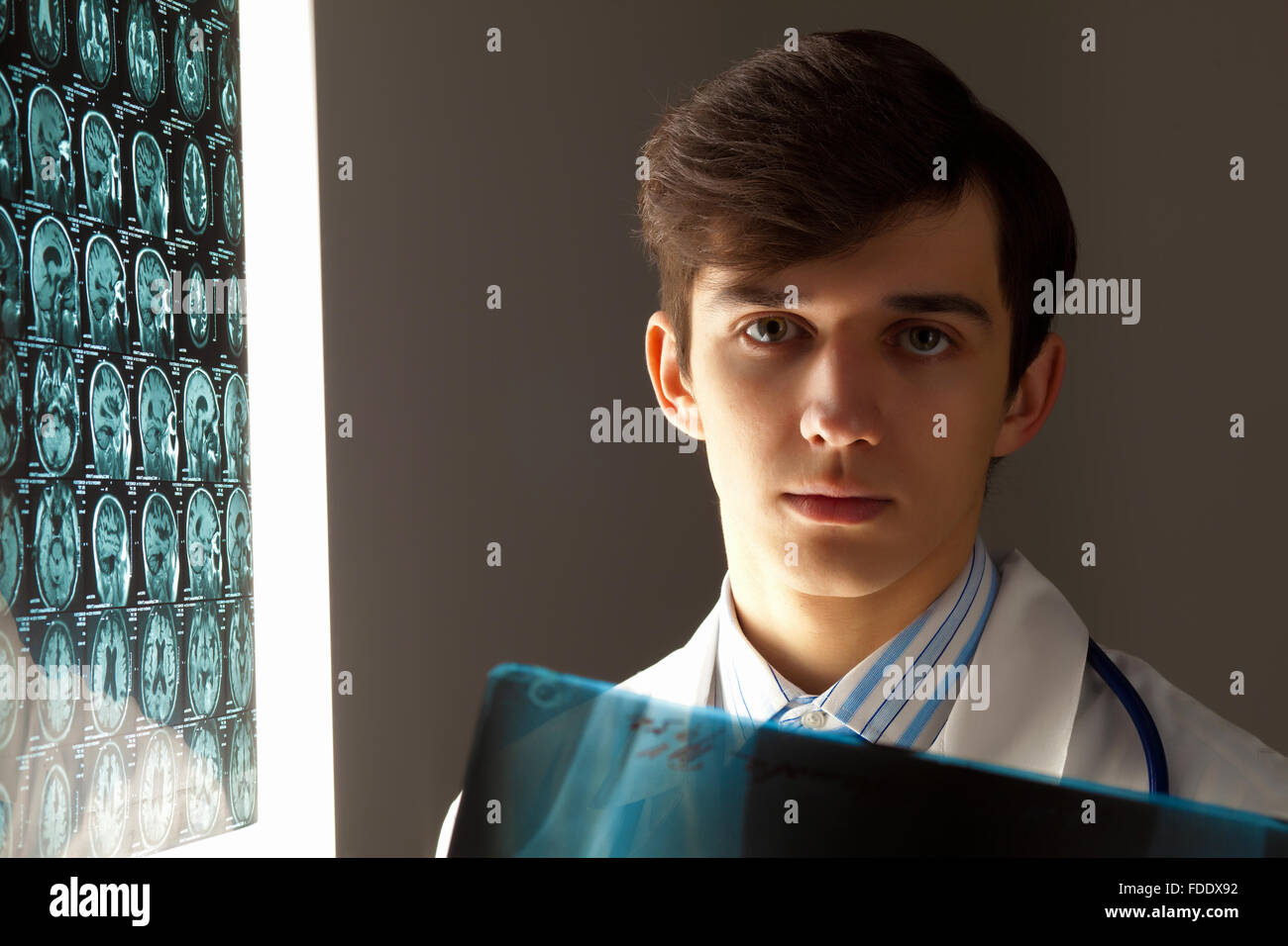 Image of male doctor holding x-ray results Stock Photo - Alamy